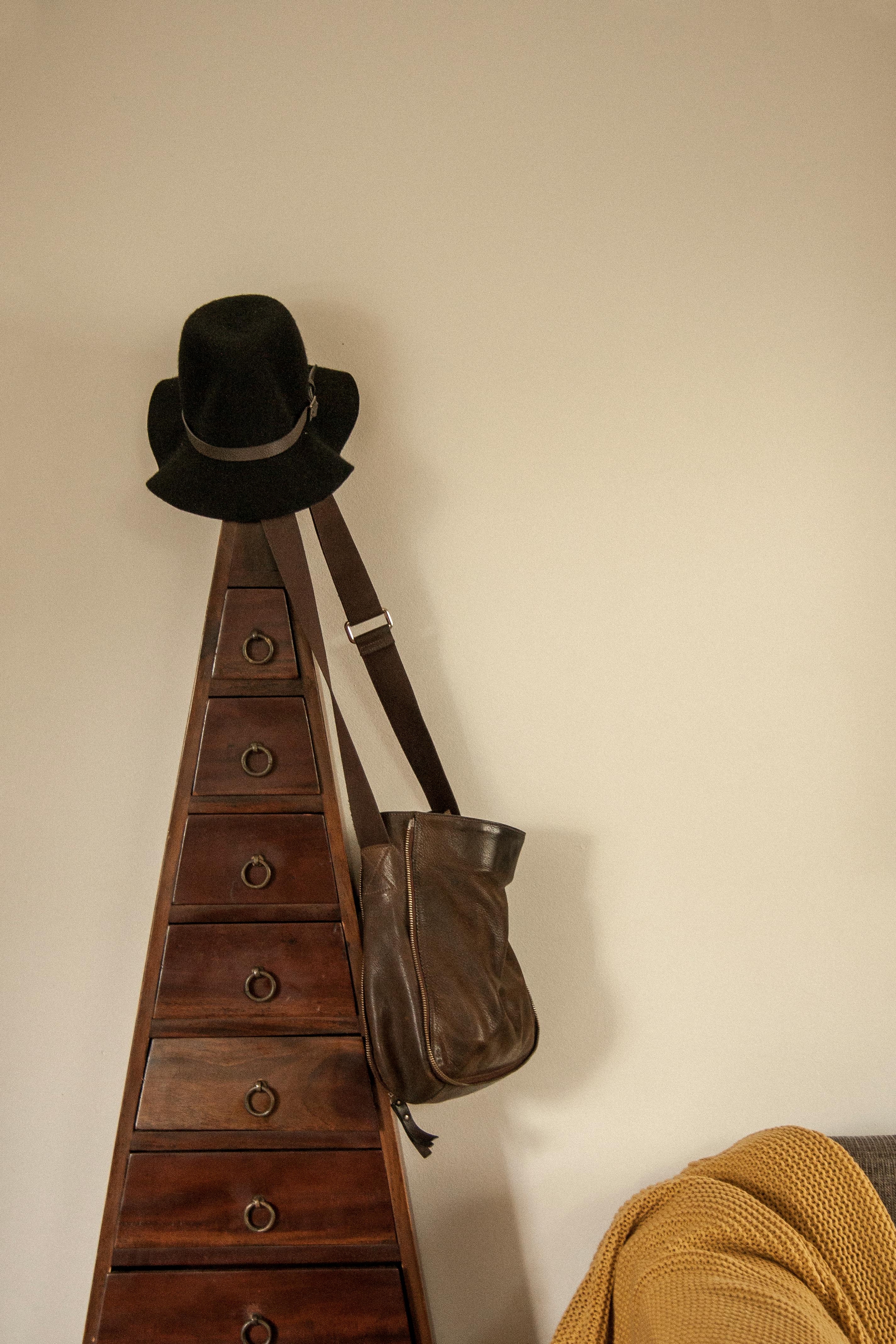Black Fedora Hat on Brown Wooden Drawer · Free Stock Photo