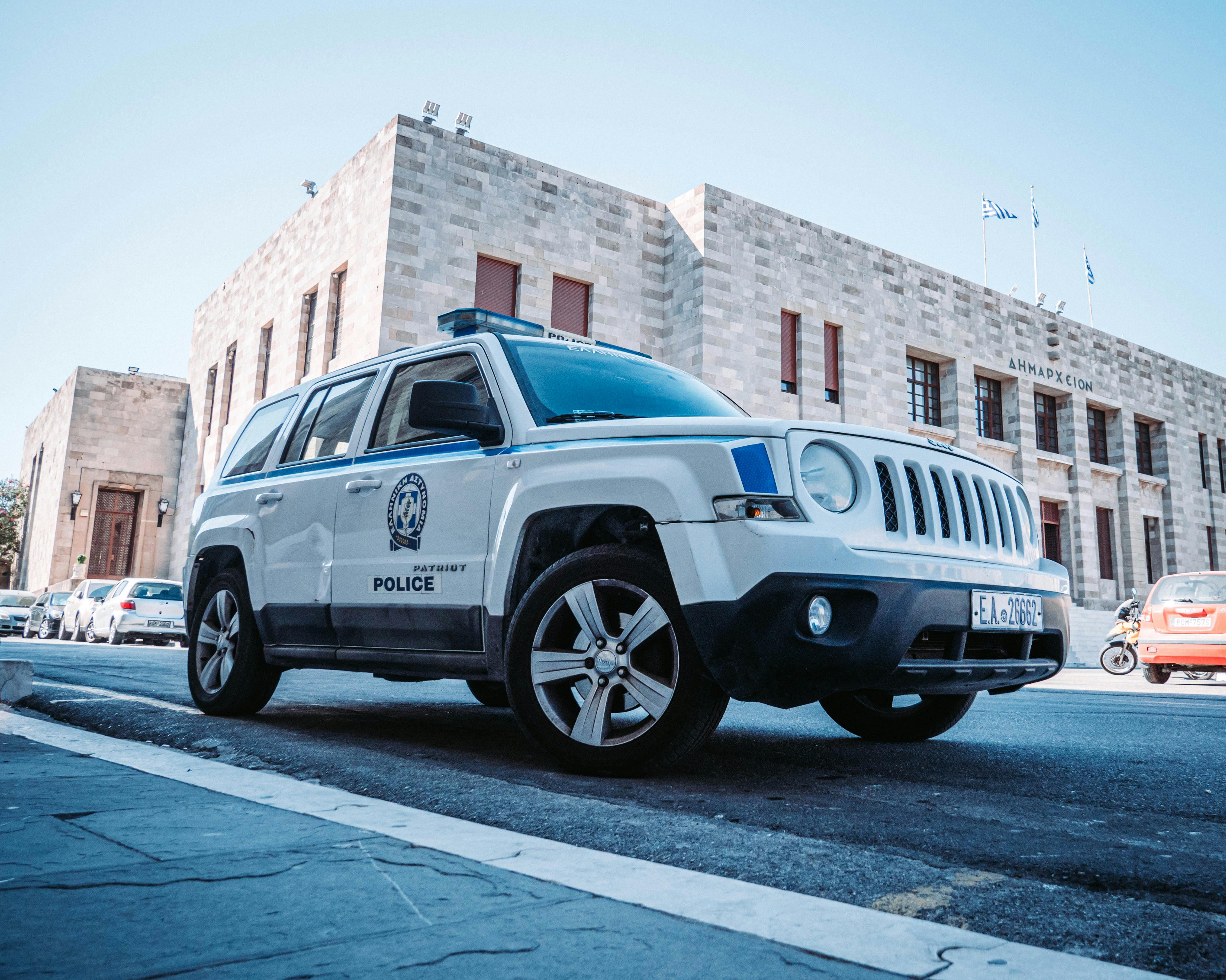 Police Car Parked Near Building · Free Stock Photo