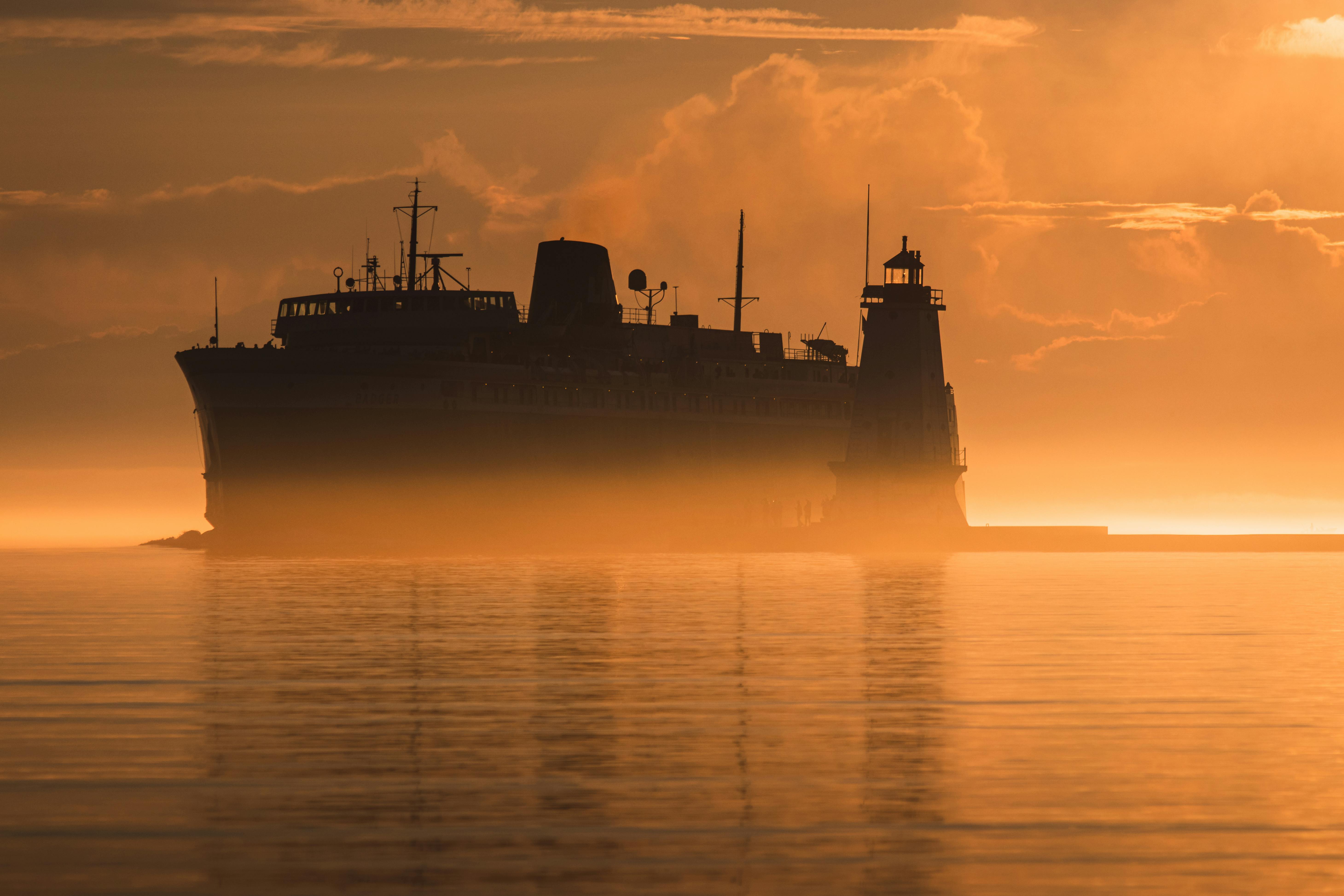 Black Ship on Sea during Dusk · Free Stock Photo