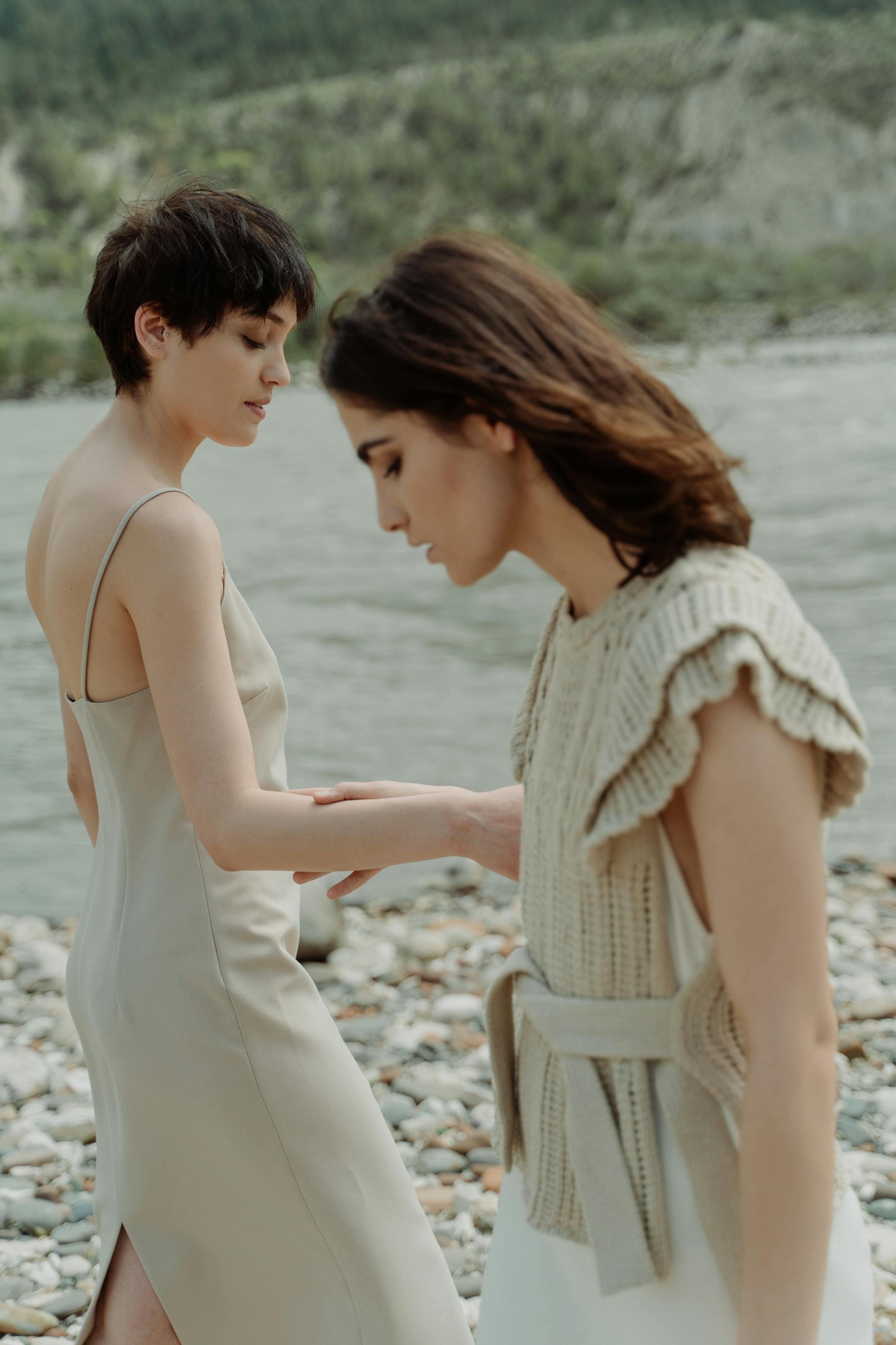 Models Wearing Beige Dresses Posing on a Lake Shore · Free Stock Photo