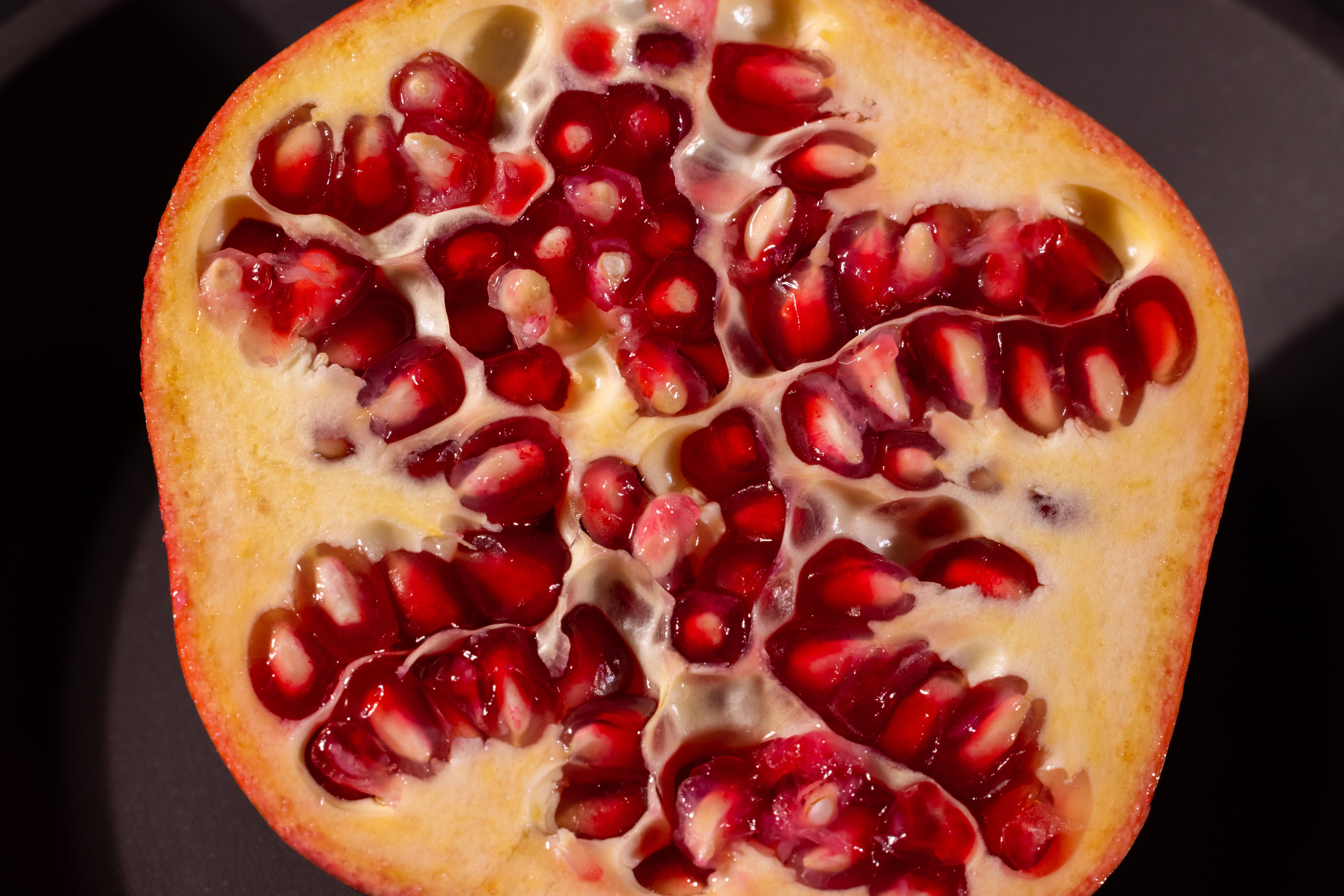 Close-Up Photograph of a Sliced Pomegranate · Free Stock Photo
