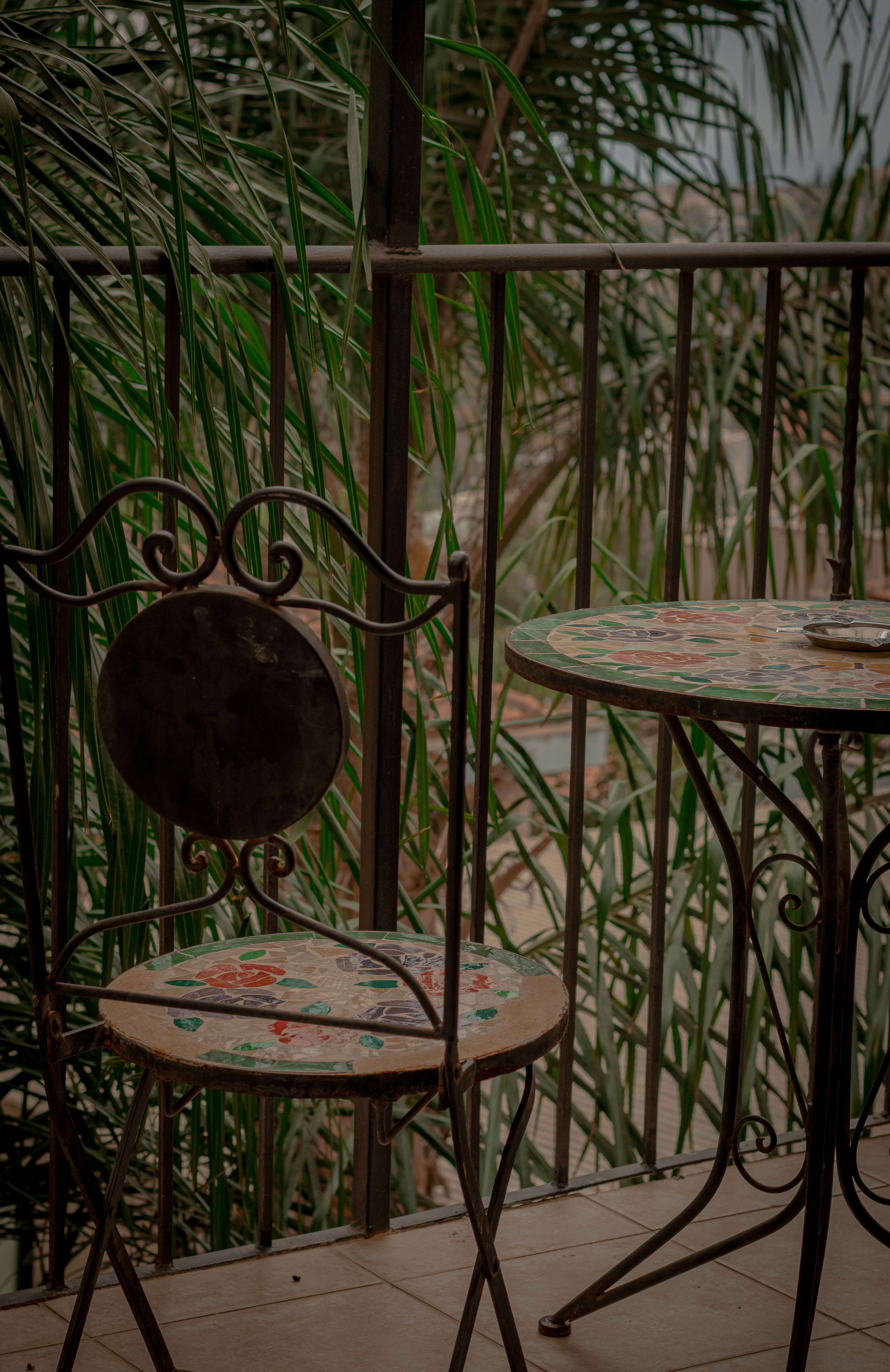 Table and Chairs on the Balcony of a Paris Apartment · Free Stock Photo