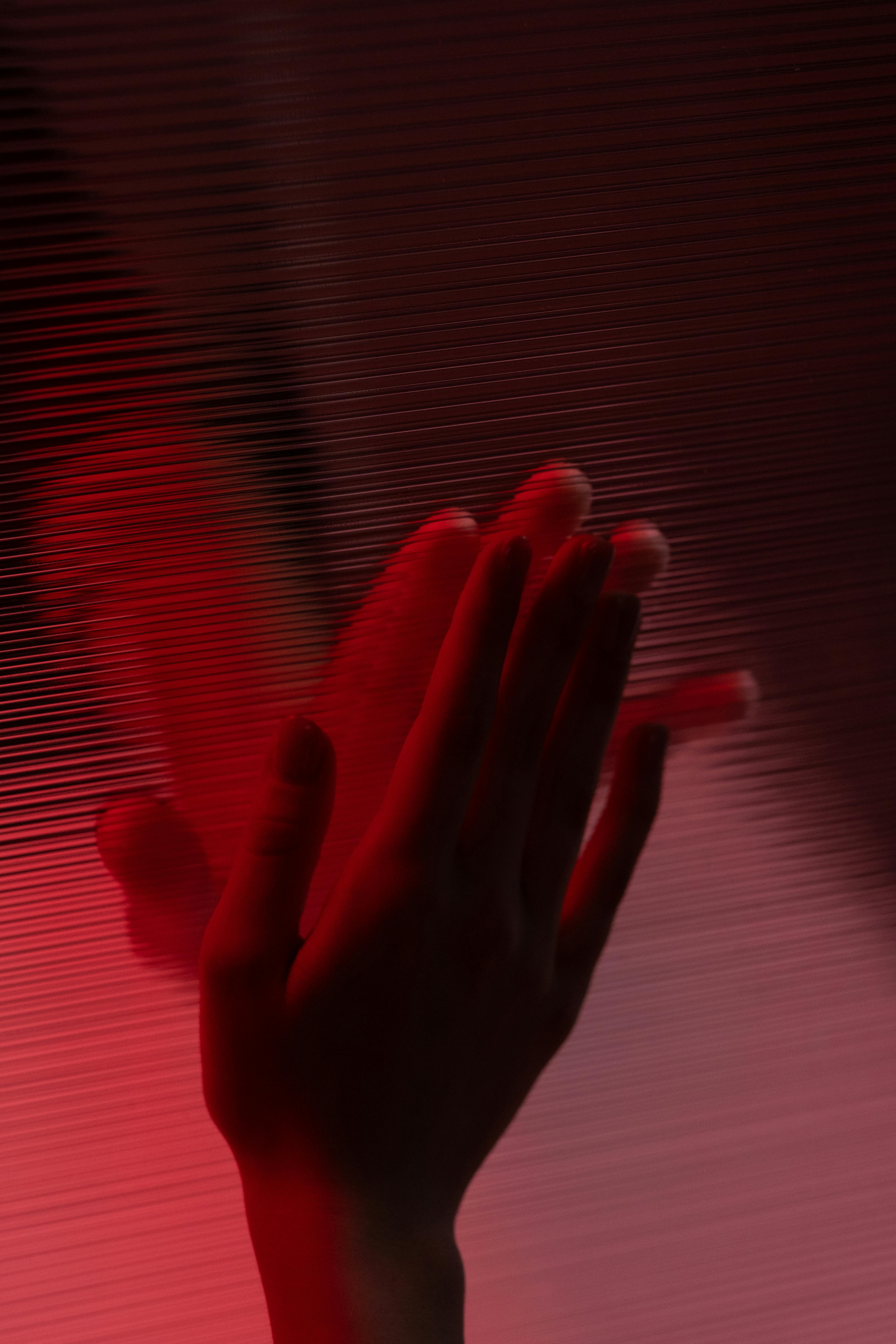 Photo of People's Hands Illuminated by Red Light · Free Stock Photo