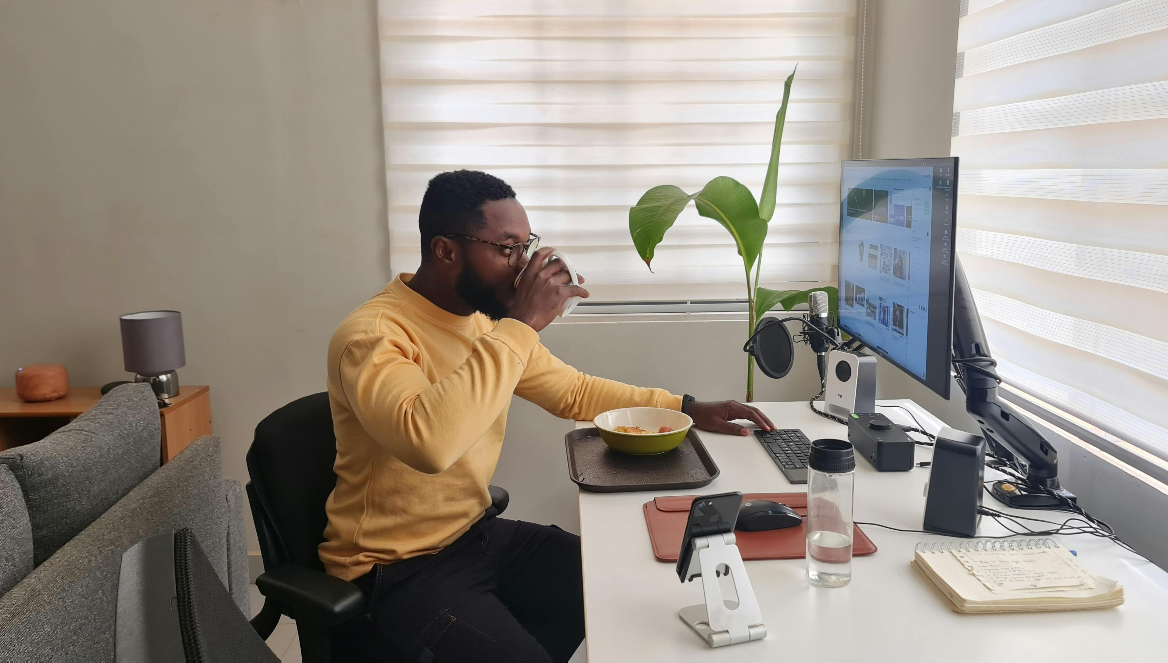 A Man Drinking While Using Computer · Free Stock Photo