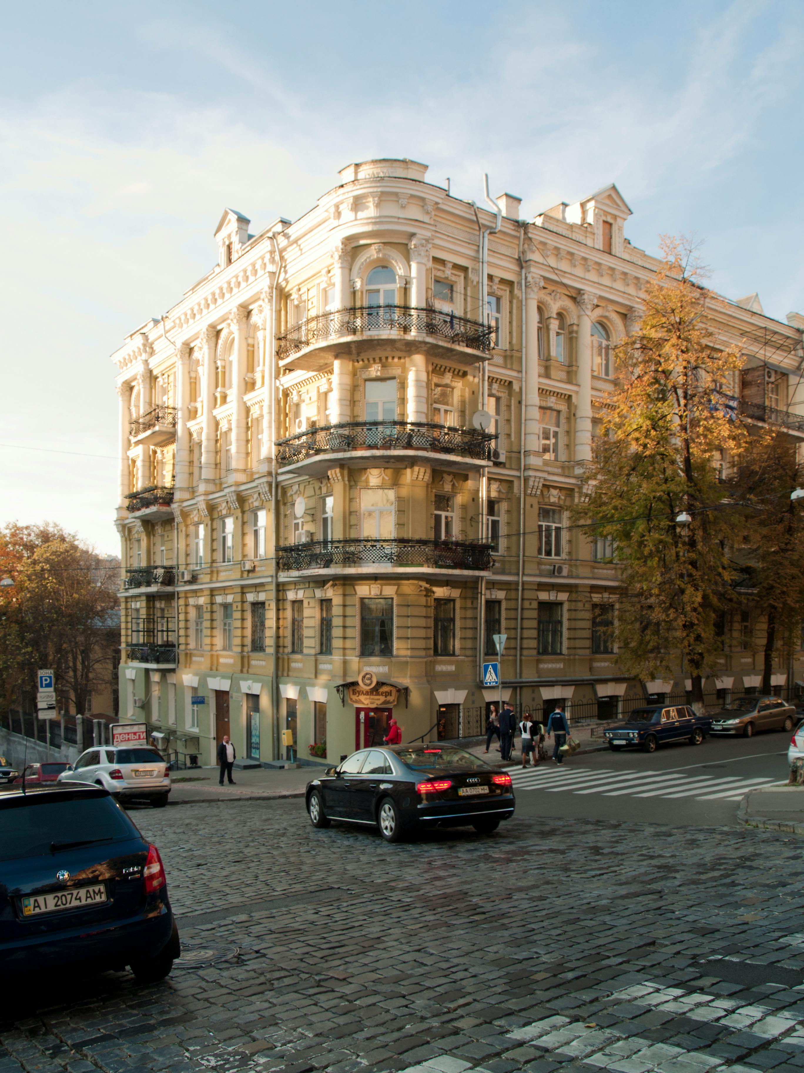 Cars on Gray Asphalt Road Near Brown Concrete Mid-rise Building · Free ...