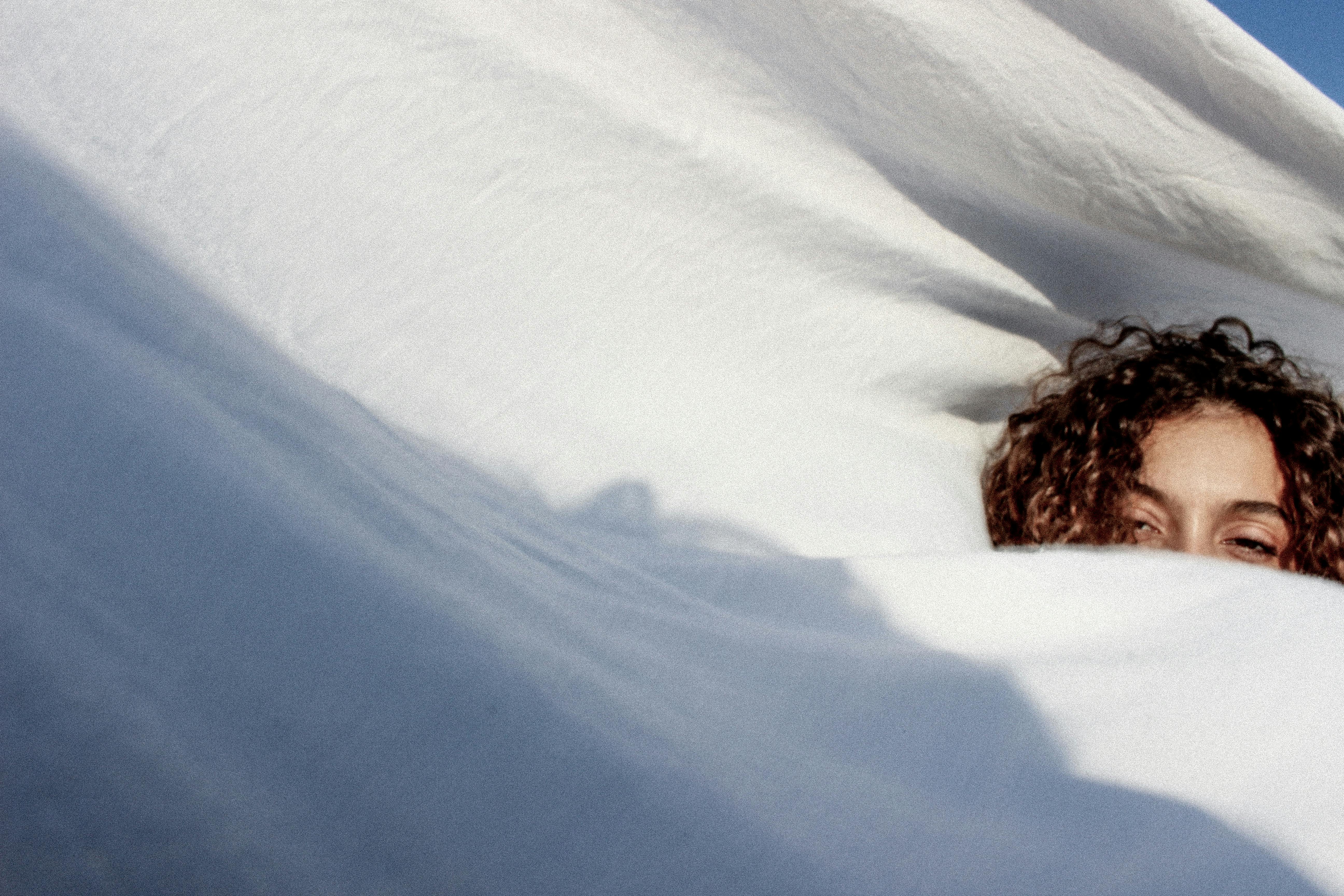 Woman under a White Blanket · Free Stock Photo