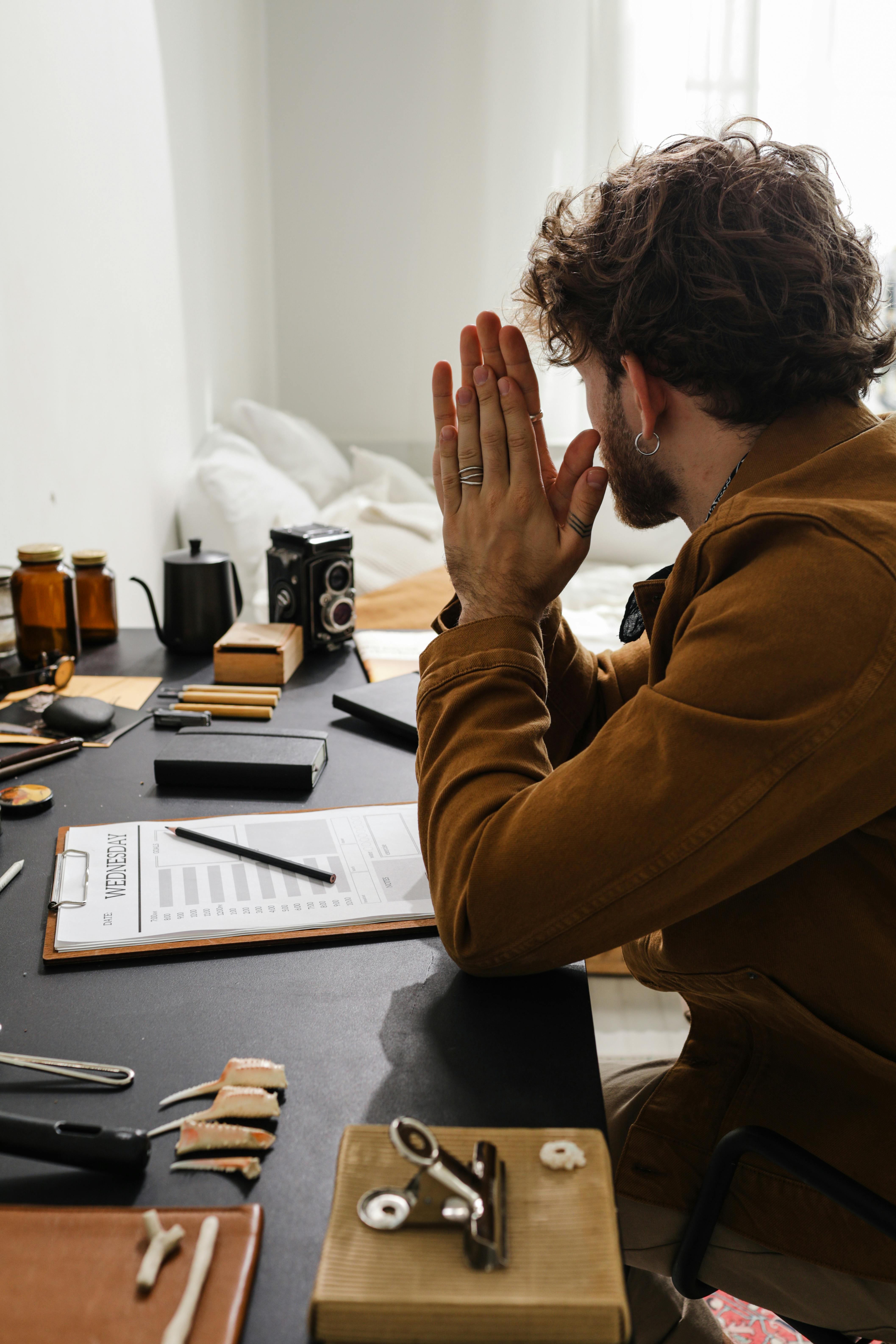 Man in Brown Jacket Sitting at Table · Free Stock Photo