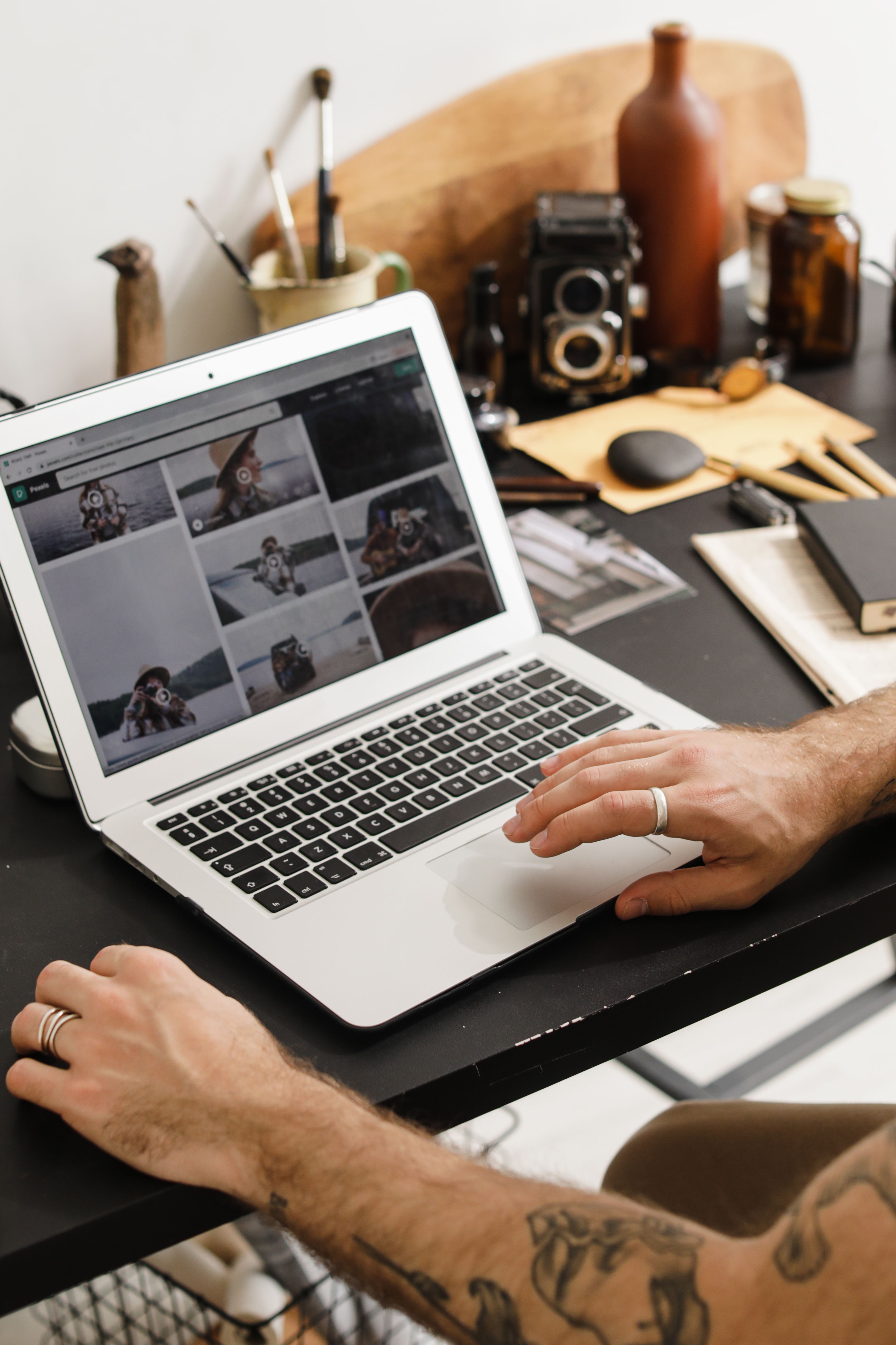 A Person Looking at Photo Shots Using a Laptop · Free Stock Photo