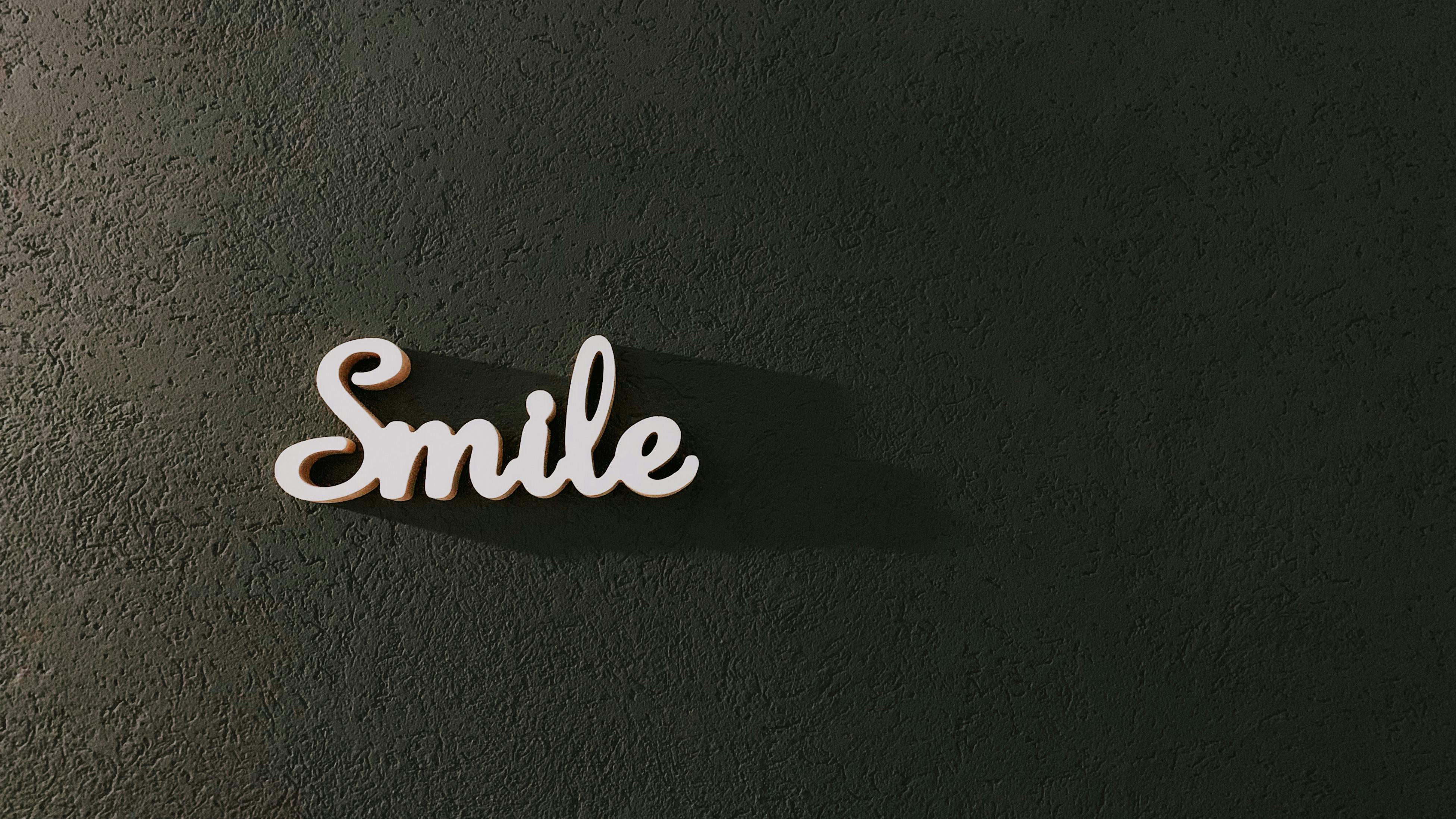 Wooden Decoration Saying a Word Smile · Free Stock Photo