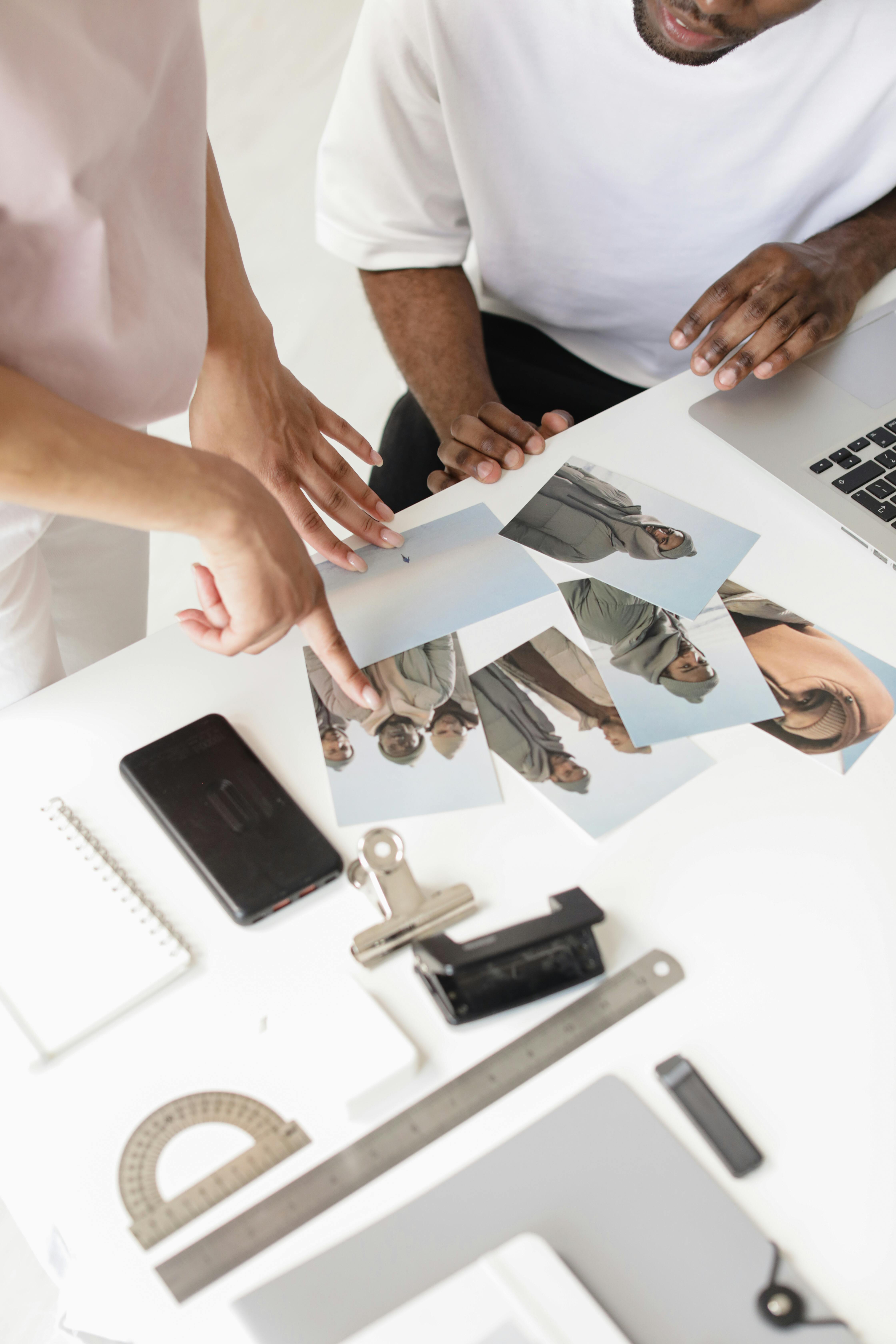Man Standing in Front of Photo Stands · Free Stock Photo