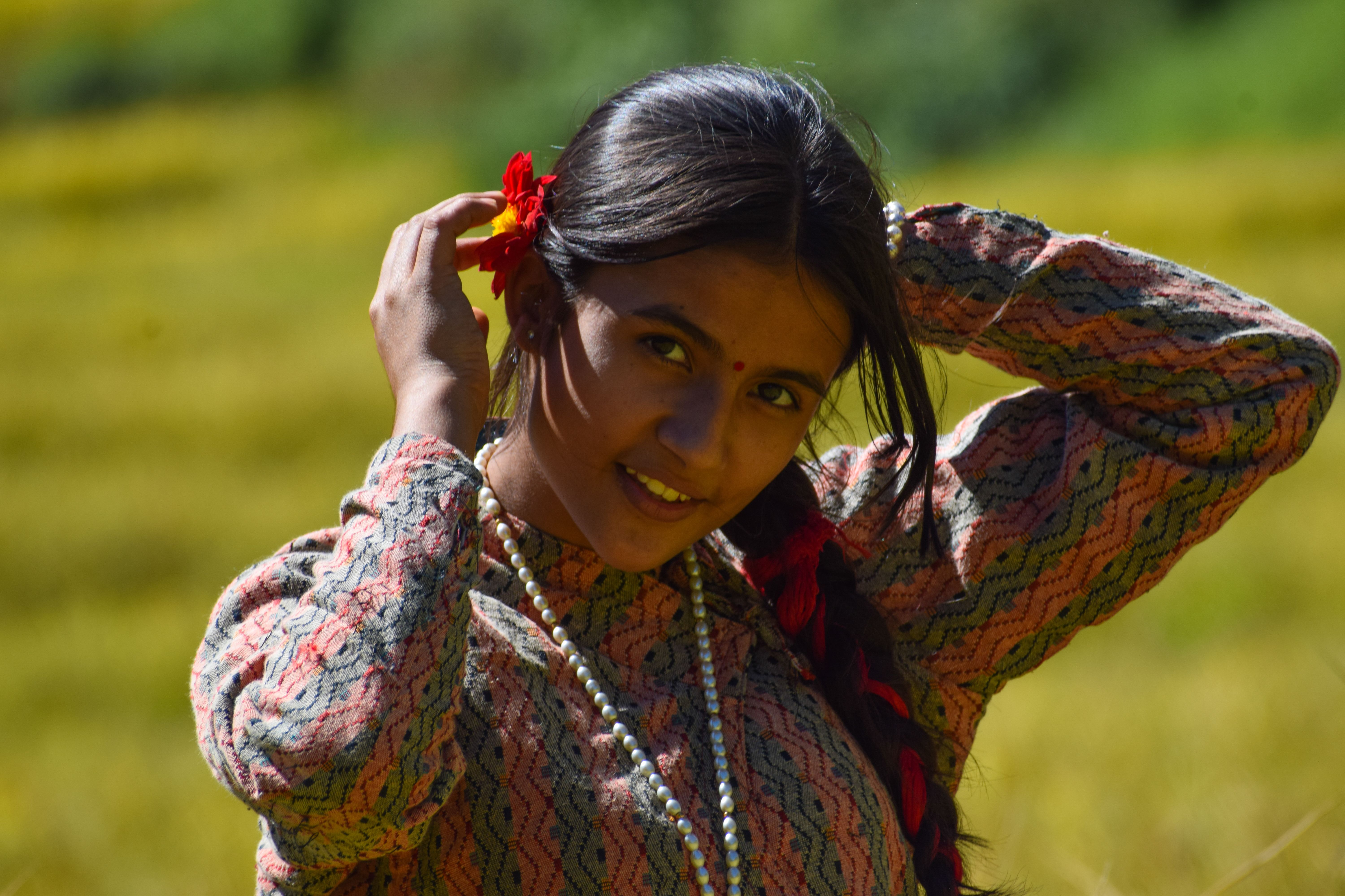 Woman putting a Flower on Her Ear · Free Stock Photo