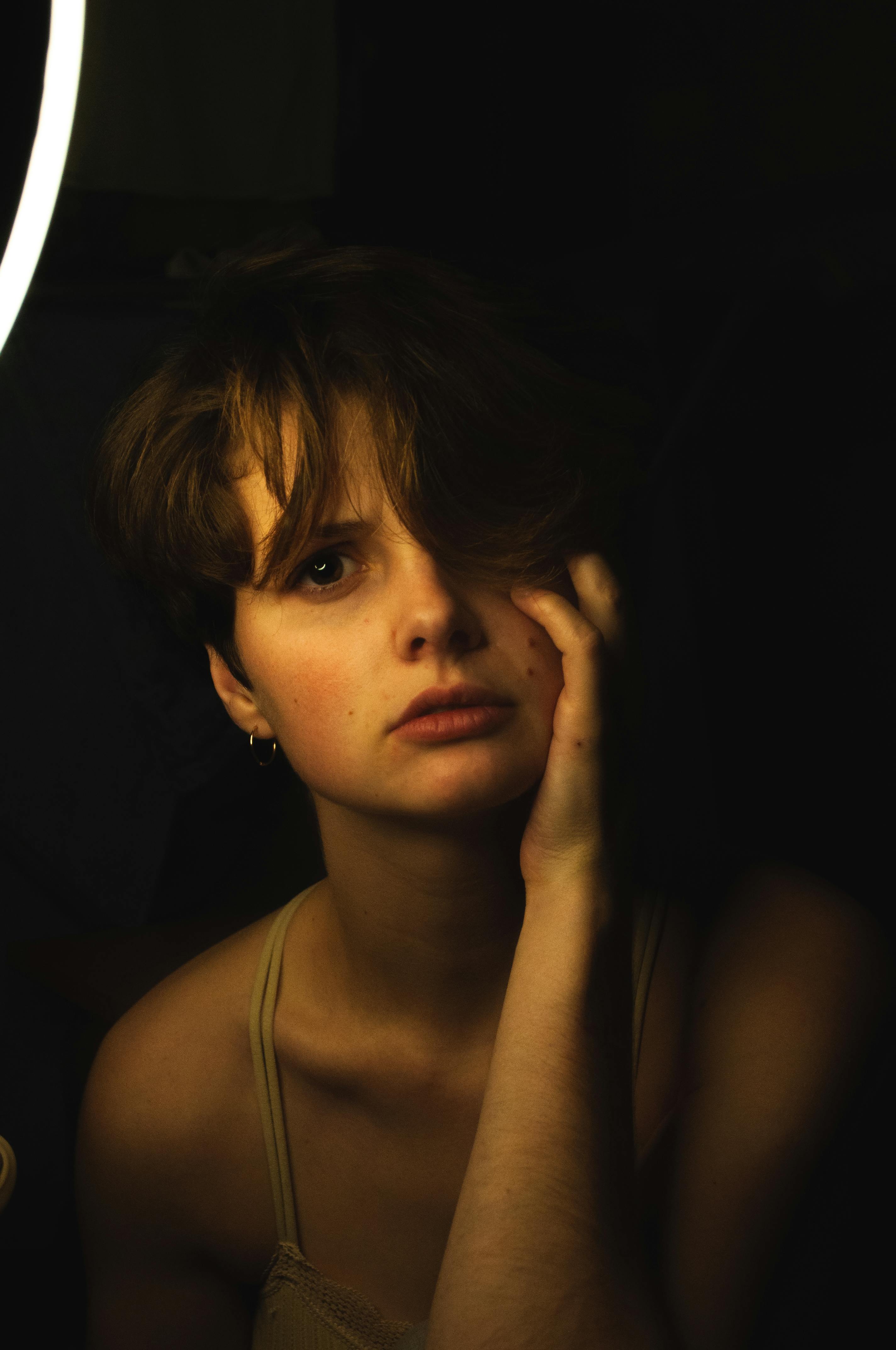 A Female Looking At Camera over Black Background · Free Stock Photo