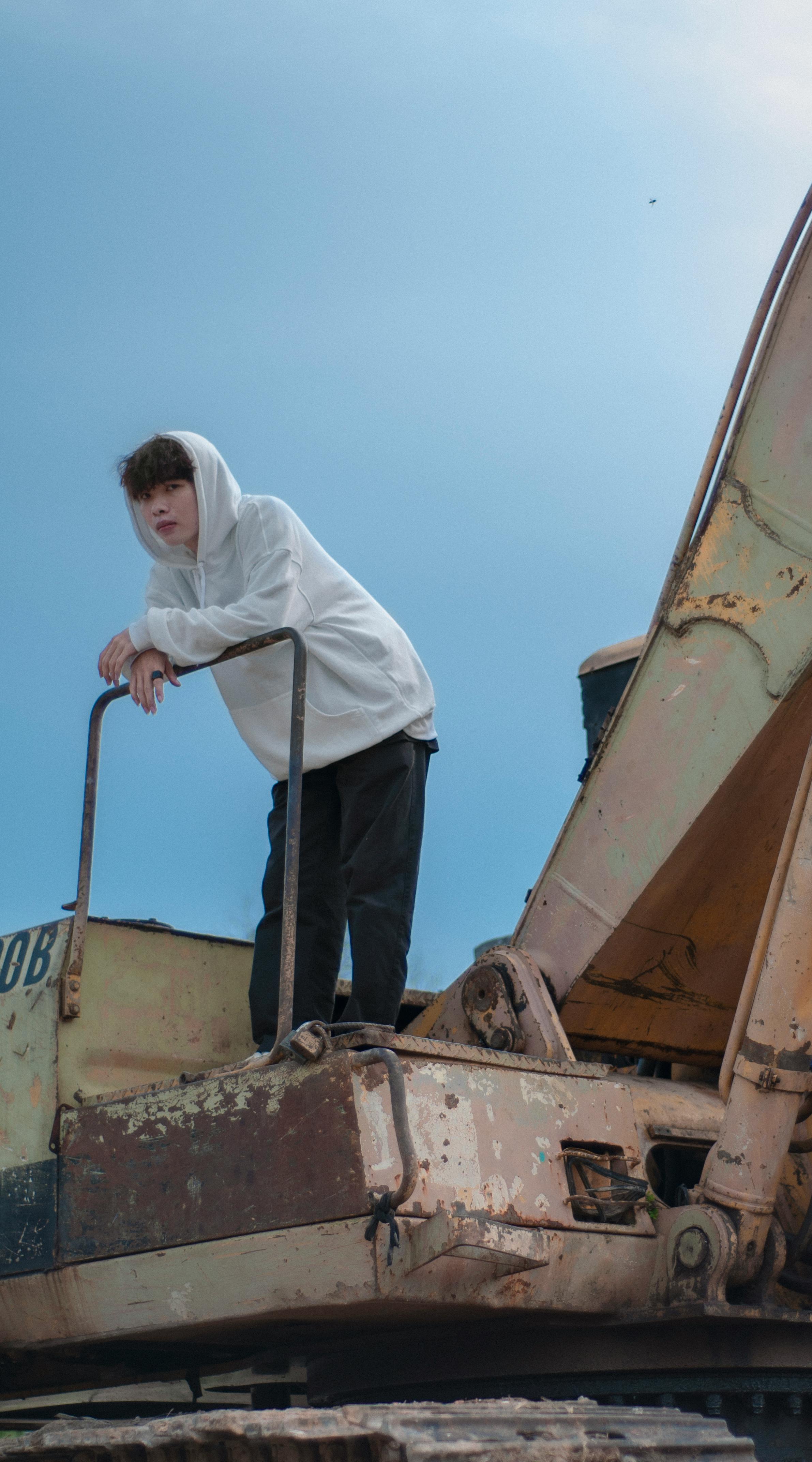Man Posing on Backhoe · Free Stock Photo