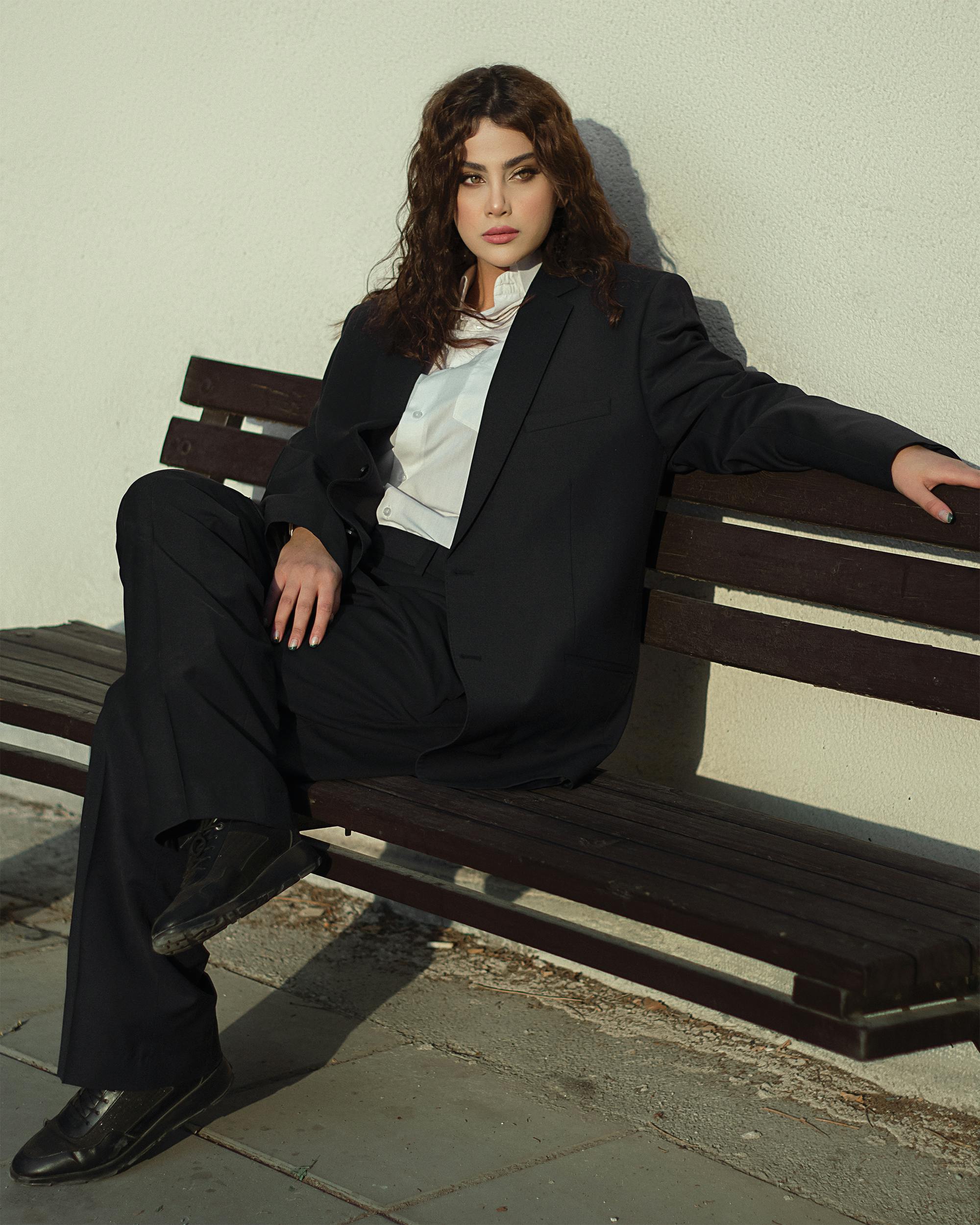 Woman in Black Suit Sitting on Brown Wooden Bench · Free Stock Photo
