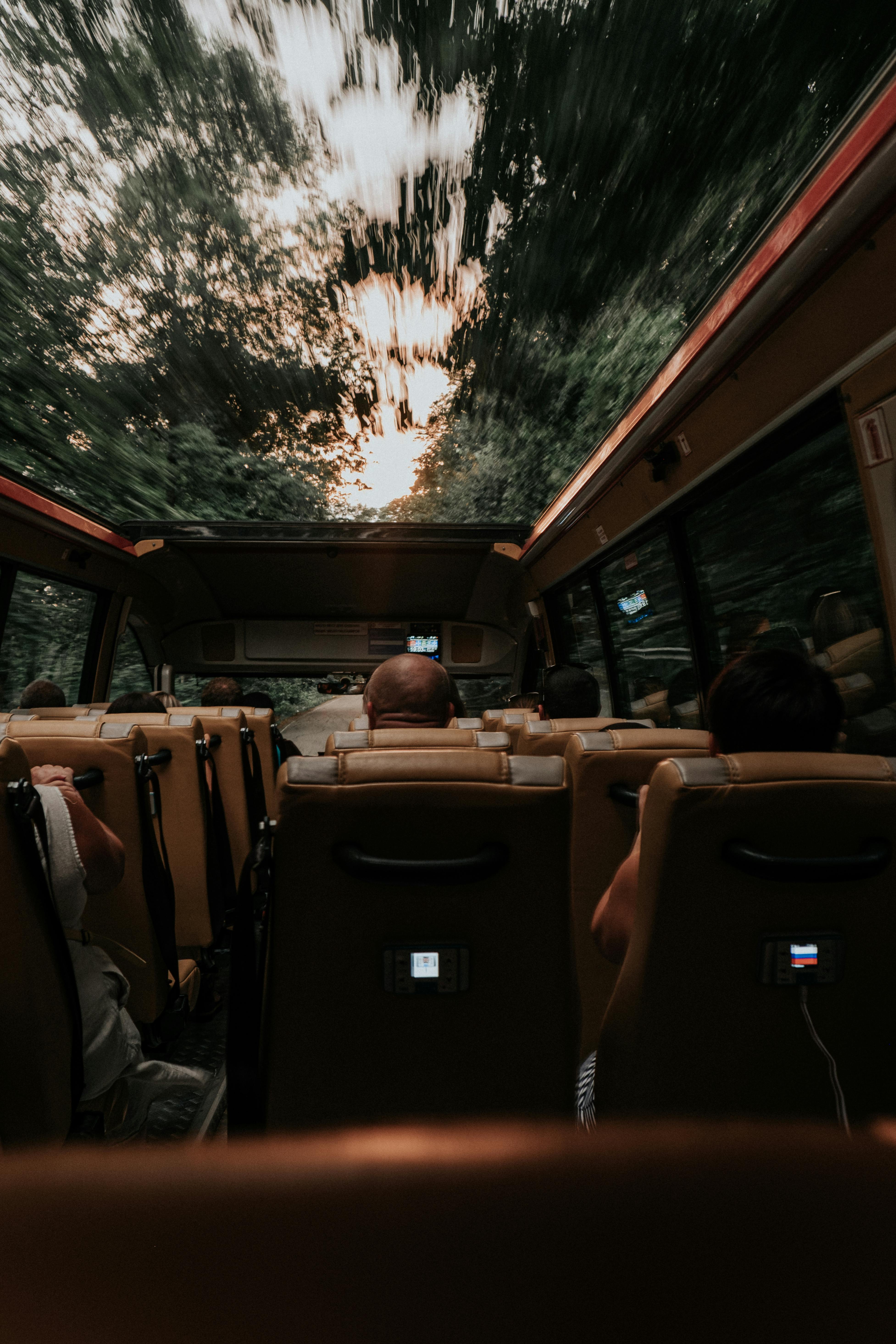 People Sitting Inside Bus With Transparent Ceiling · Free Stock Photo