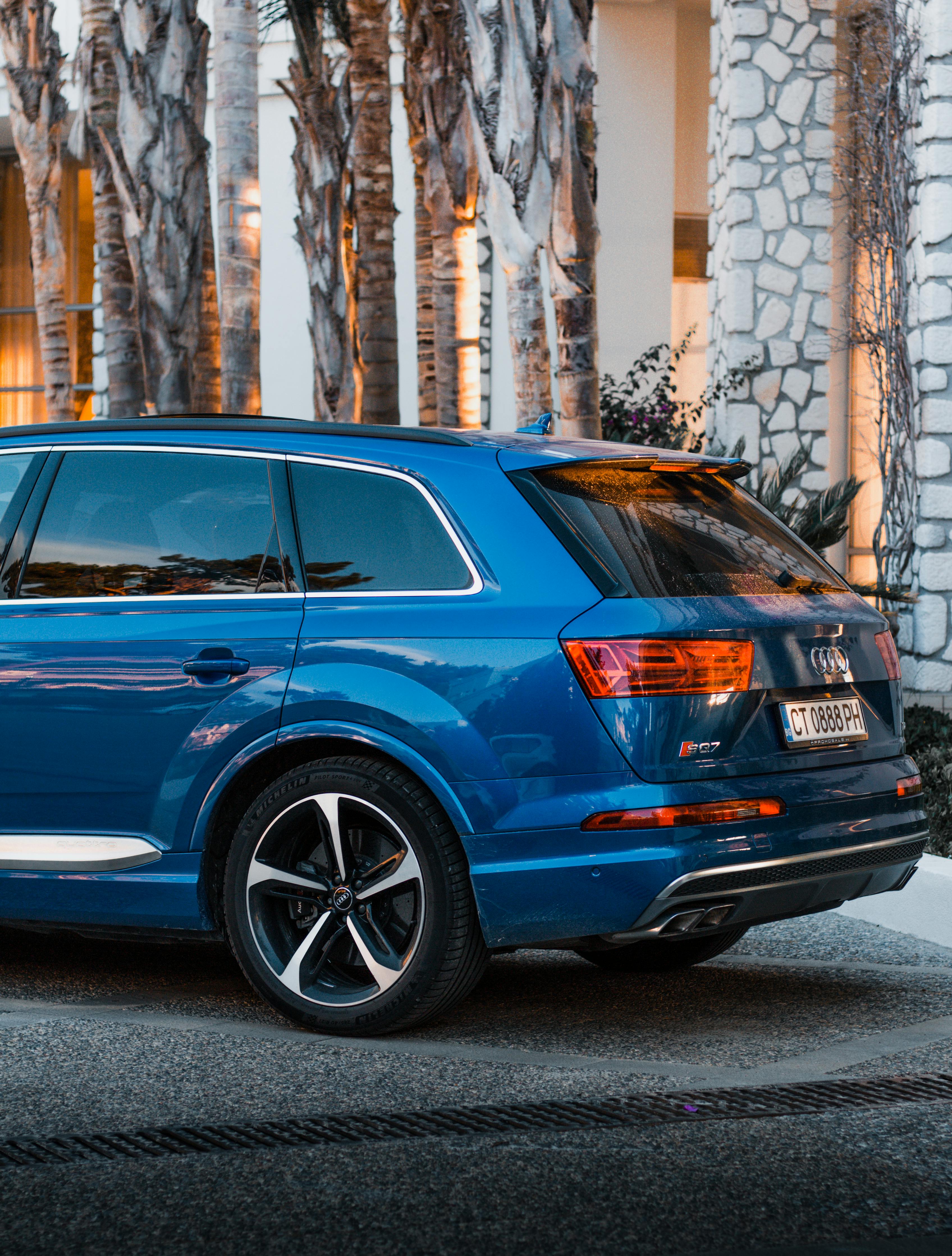 A Parked Blue Audi SQ7 Near Trees · Free Stock Photo