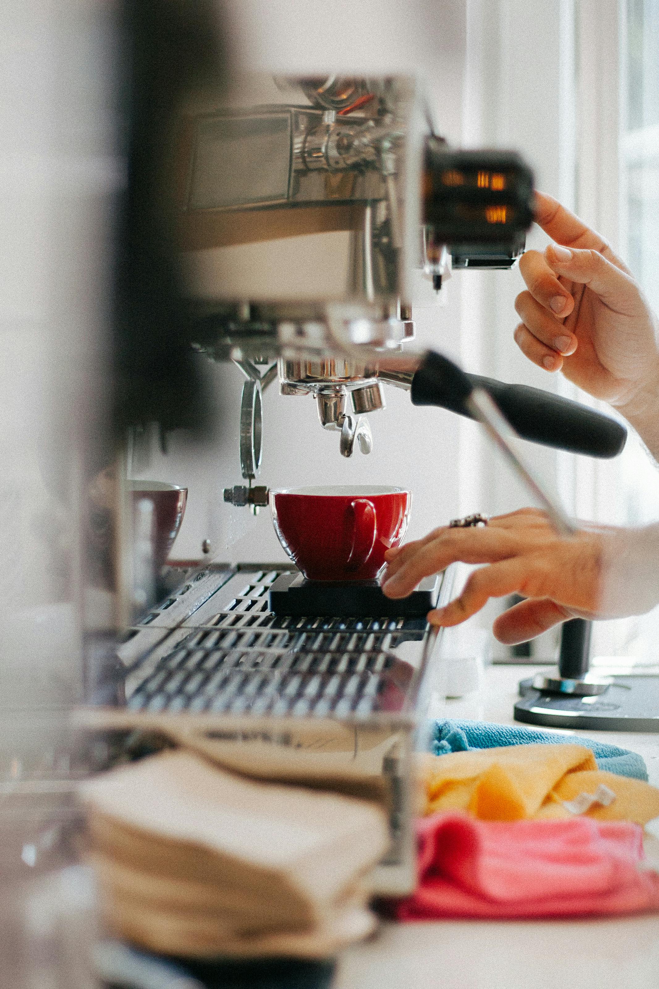 Close-up of Hand Holding Coffee Machine · Free Stock Photo