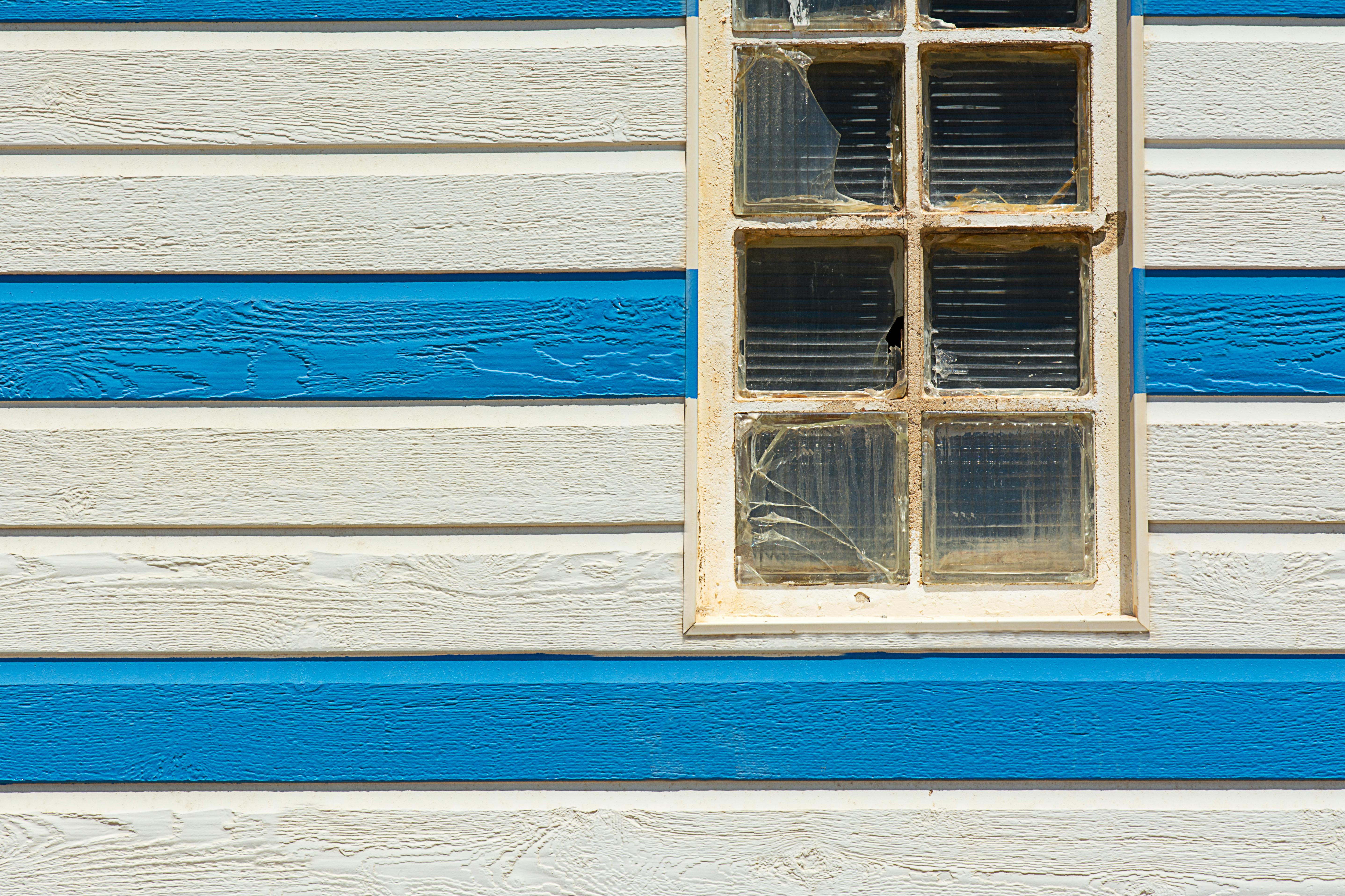 A Close-Up Shot of Broken Glass Panels of a Window · Free Stock Photo