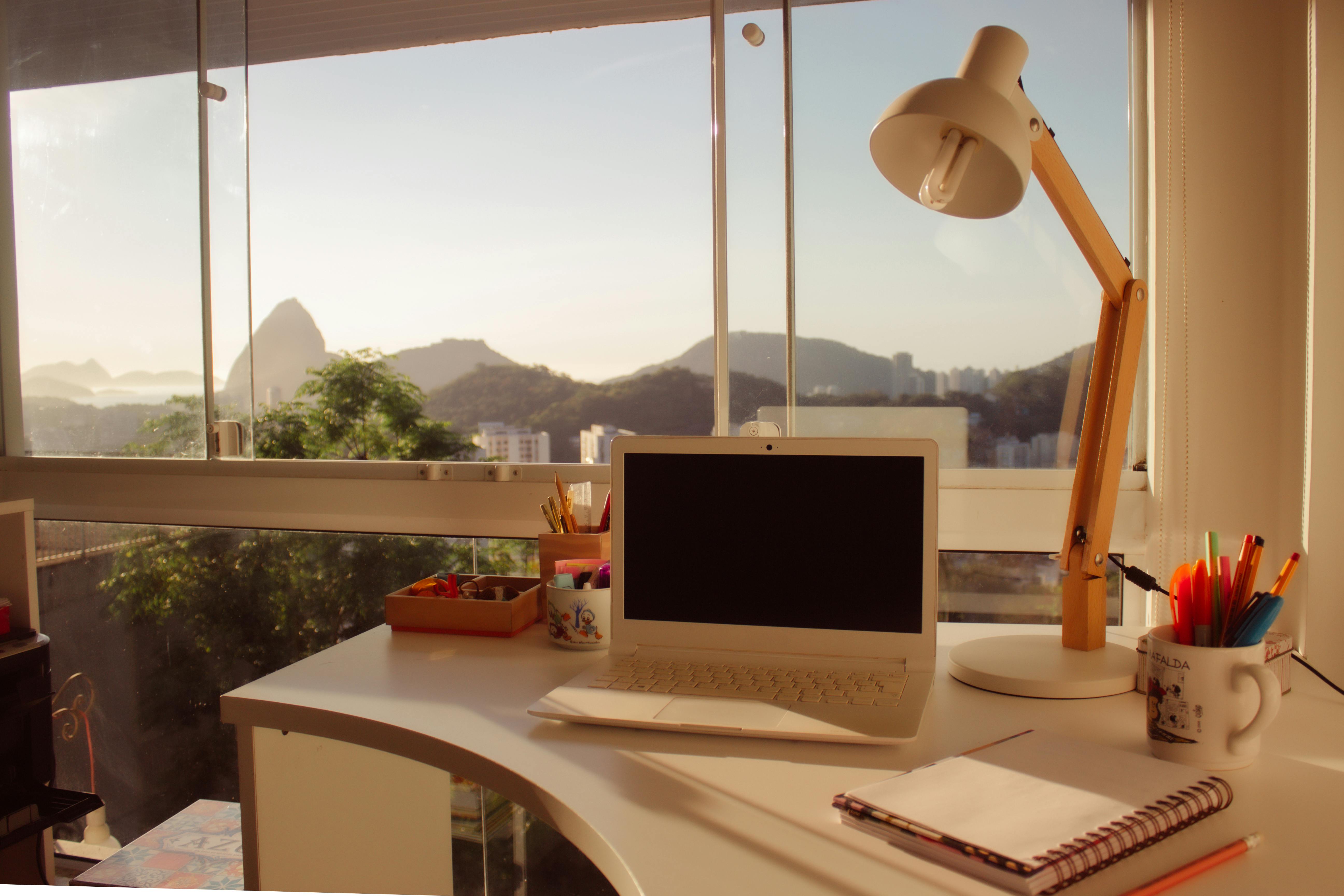 Desk and Laptop with a Window View of Mountains · Free Stock Photo