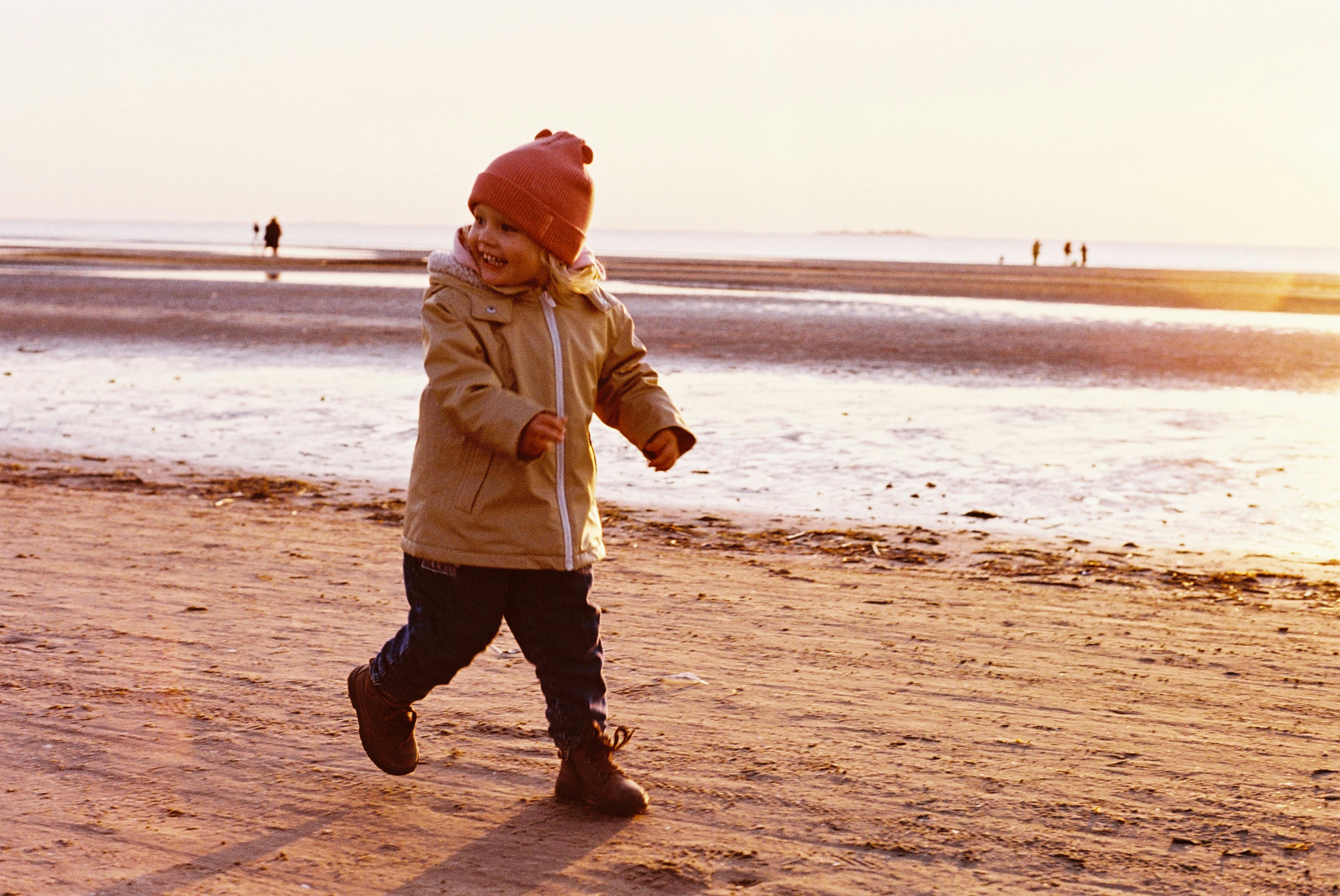 Adorable Child running on Sand · Free Stock Photo