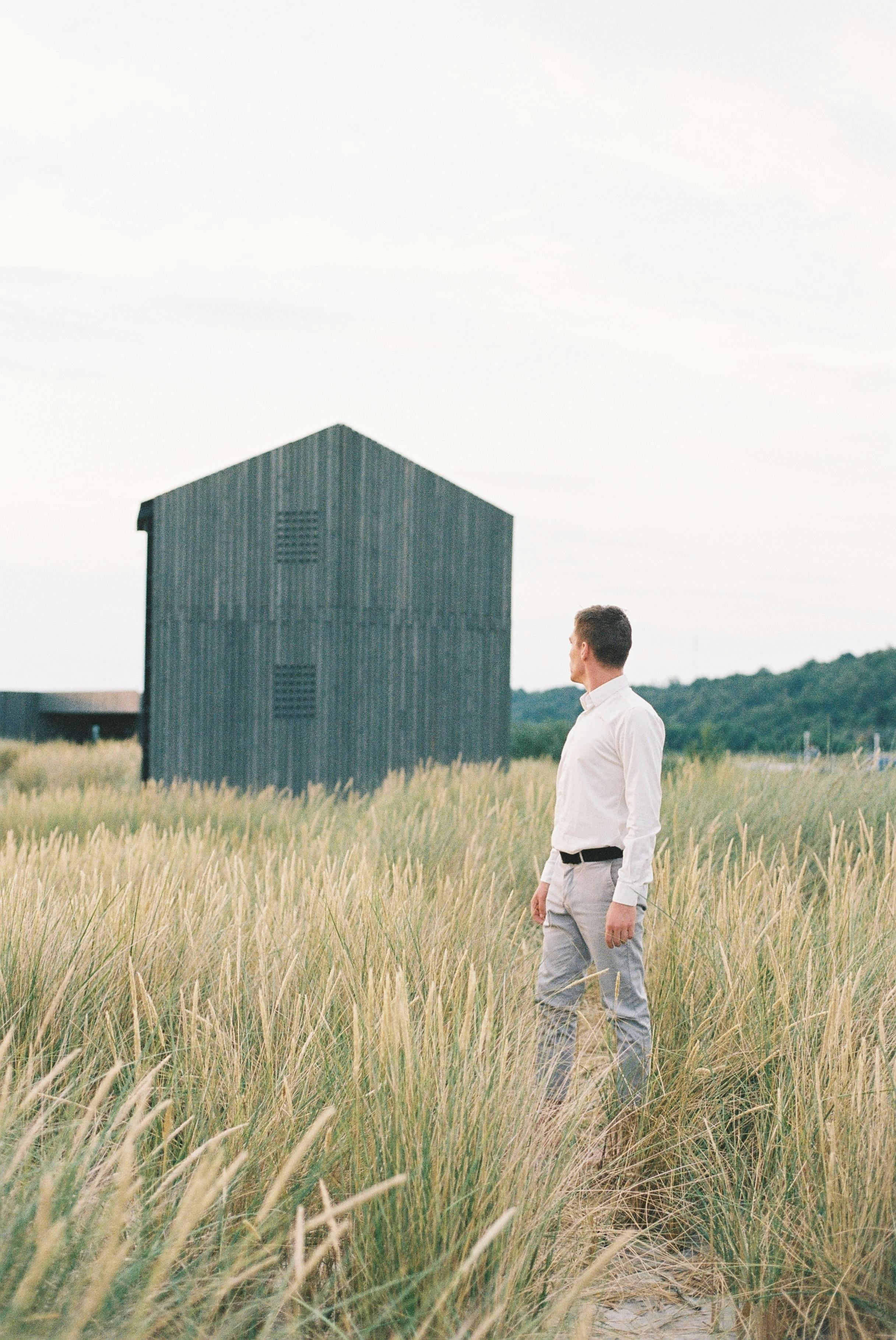 A Man Standing in the Grass Field · Free Stock Photo