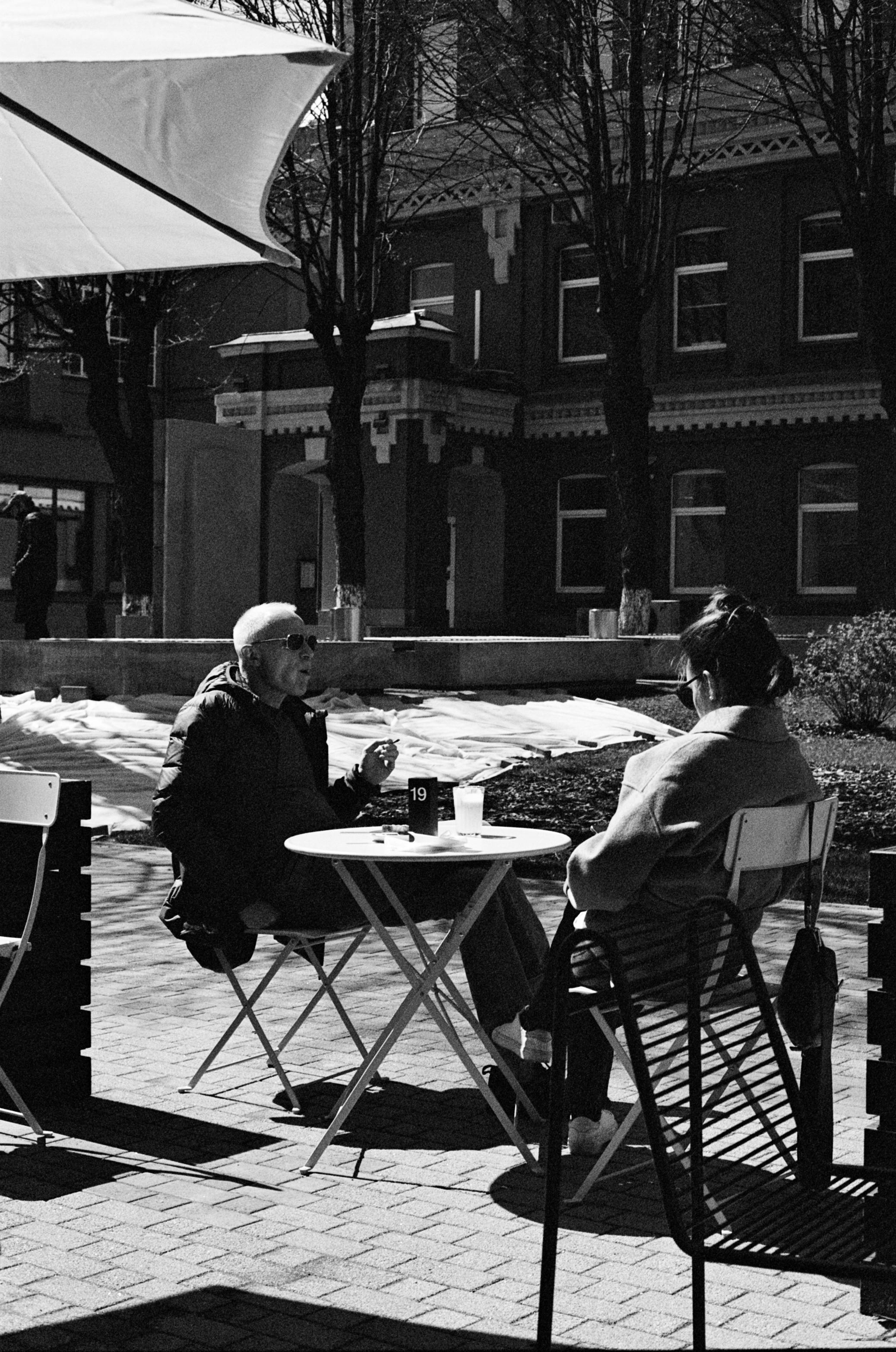 Group Of Men Outside A Coffee Shop · Free Stock Photo