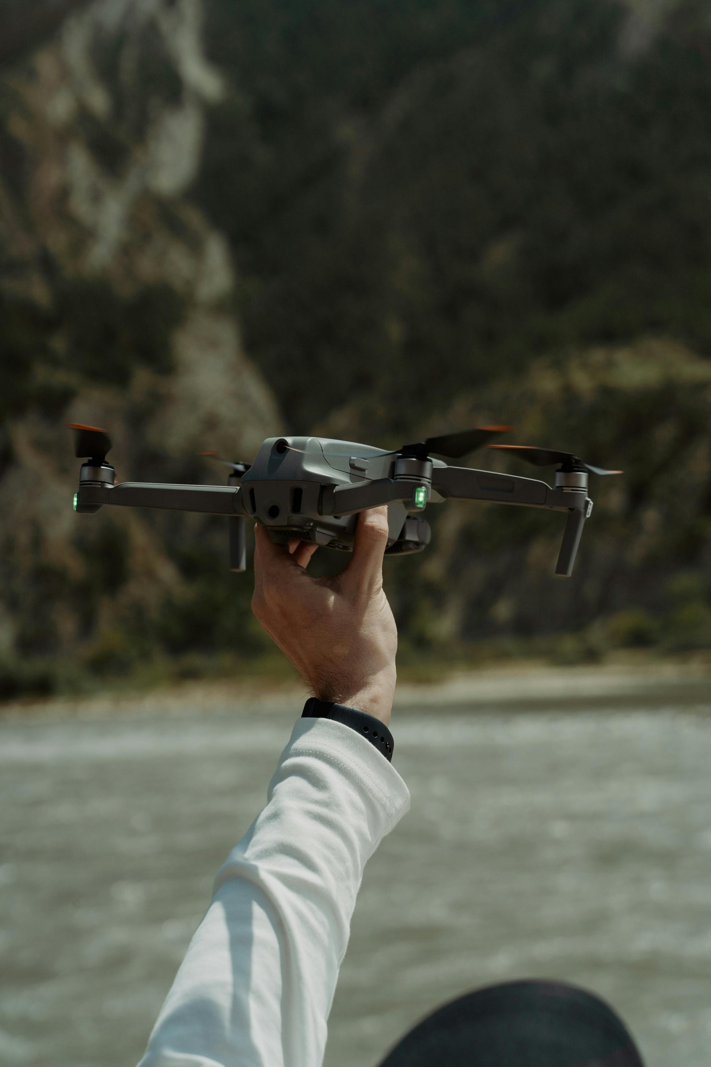 A Person Holding a Drone Ready for Take Off · Free Stock Photo