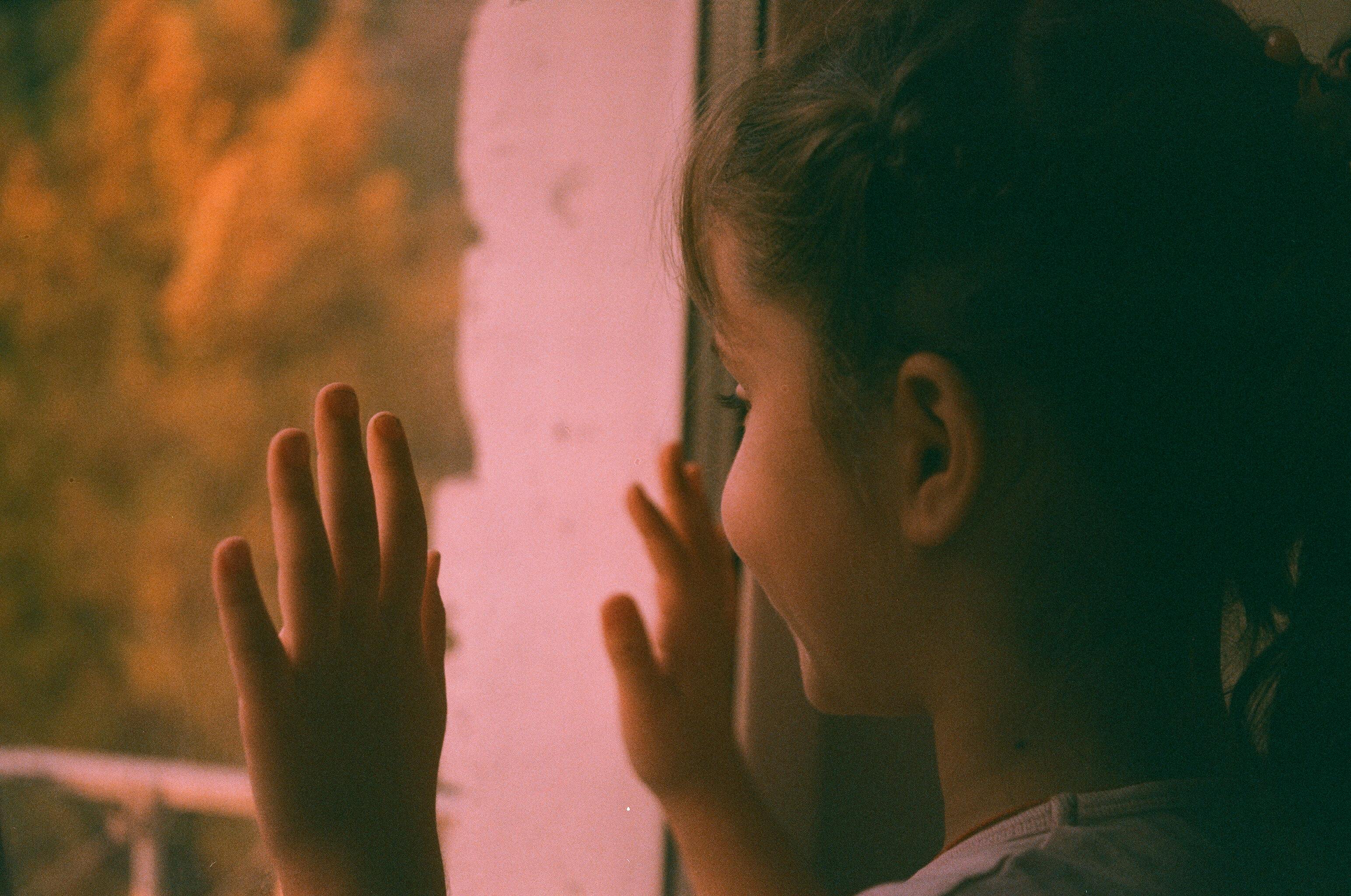 A Young Girl Looking at the Glass Window · Free Stock Photo