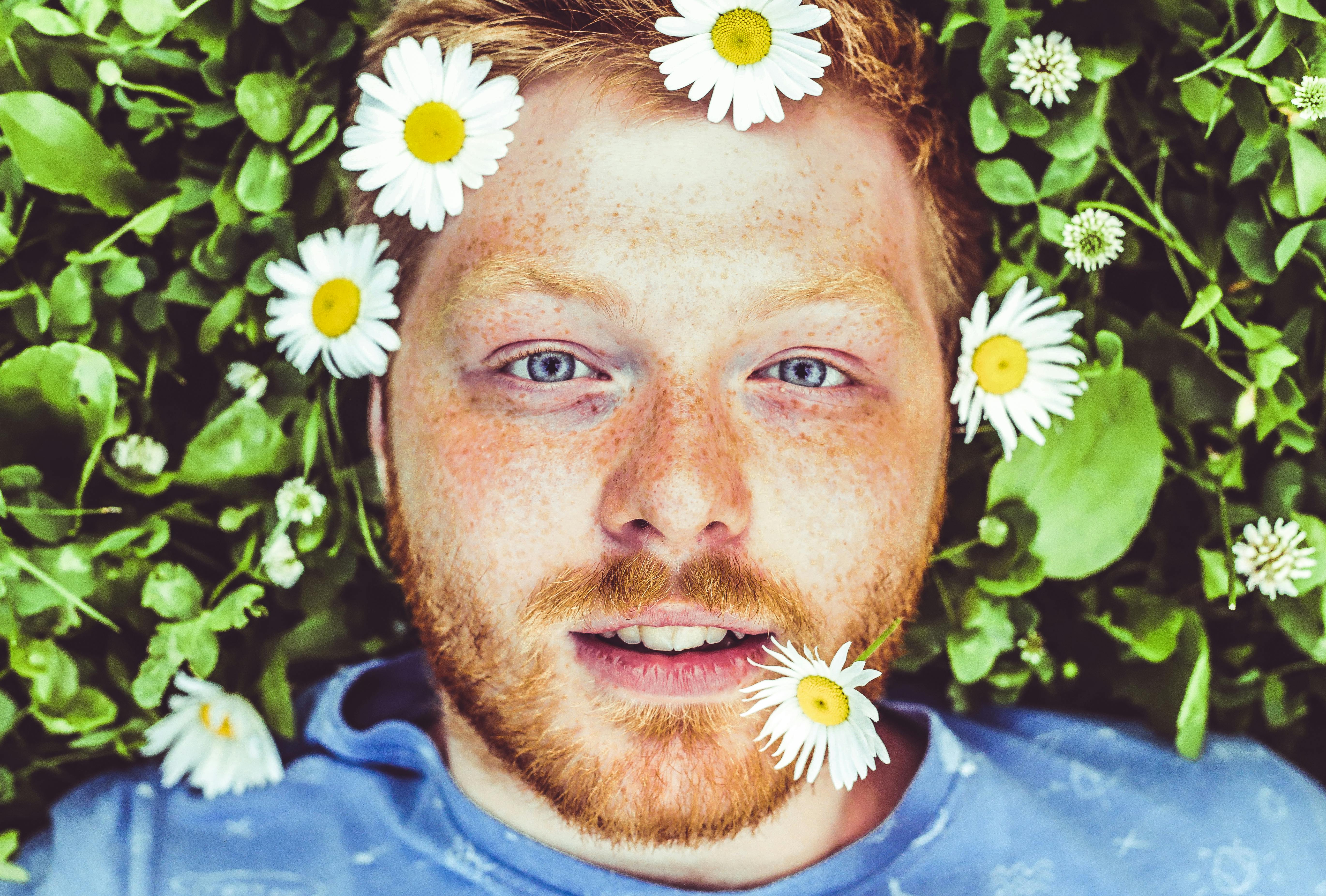 A Man with Daisy Flowers to his Face · Free Stock Photo