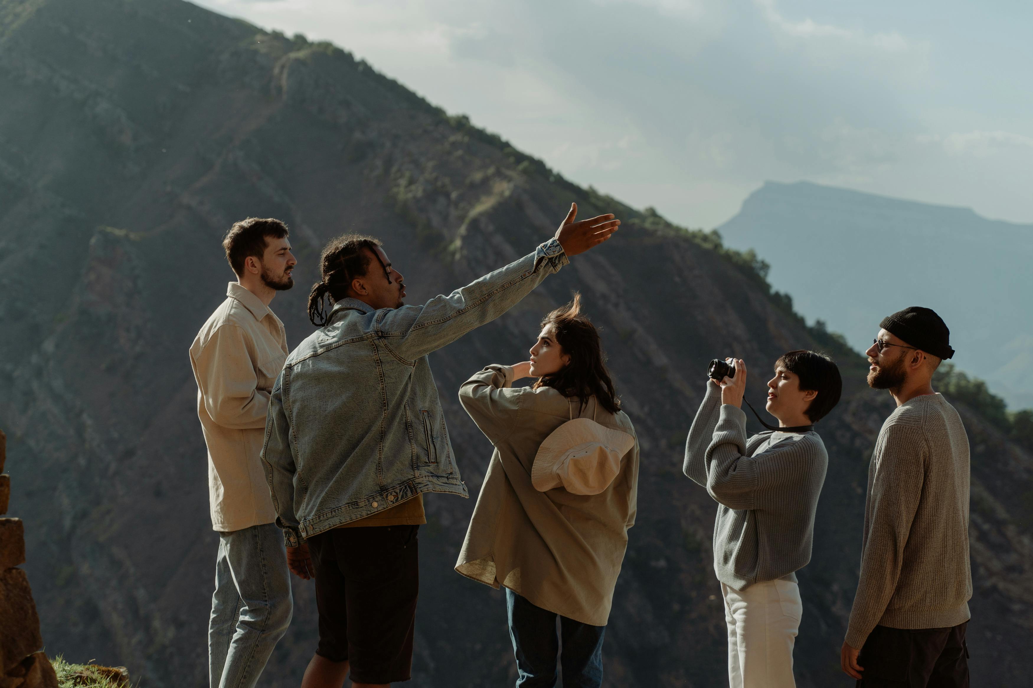 Three Men Standing Near Body of Water · Free Stock Photo