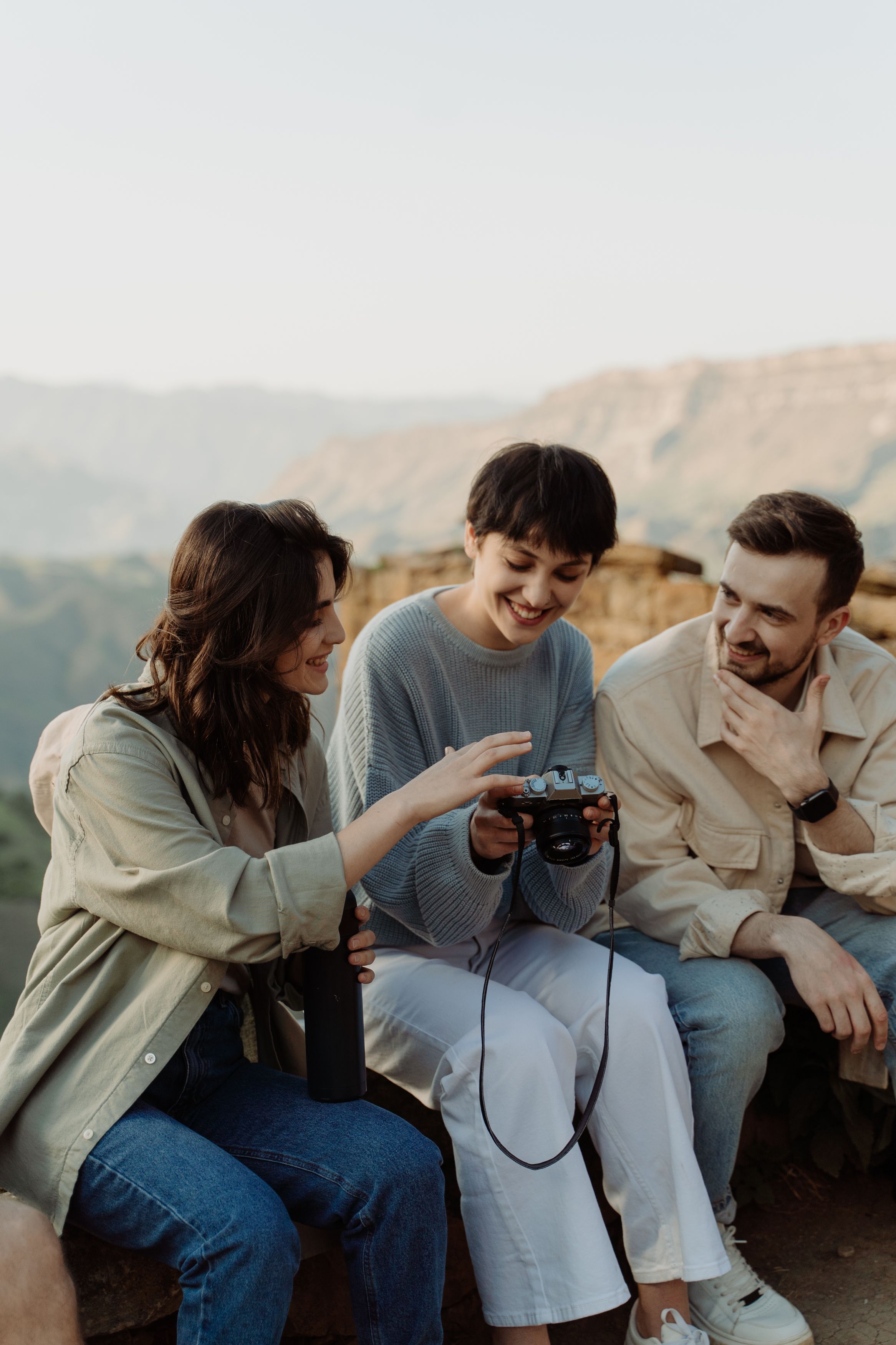 A Group of People Looking at Photo Shots in a Camera · Free Stock Photo