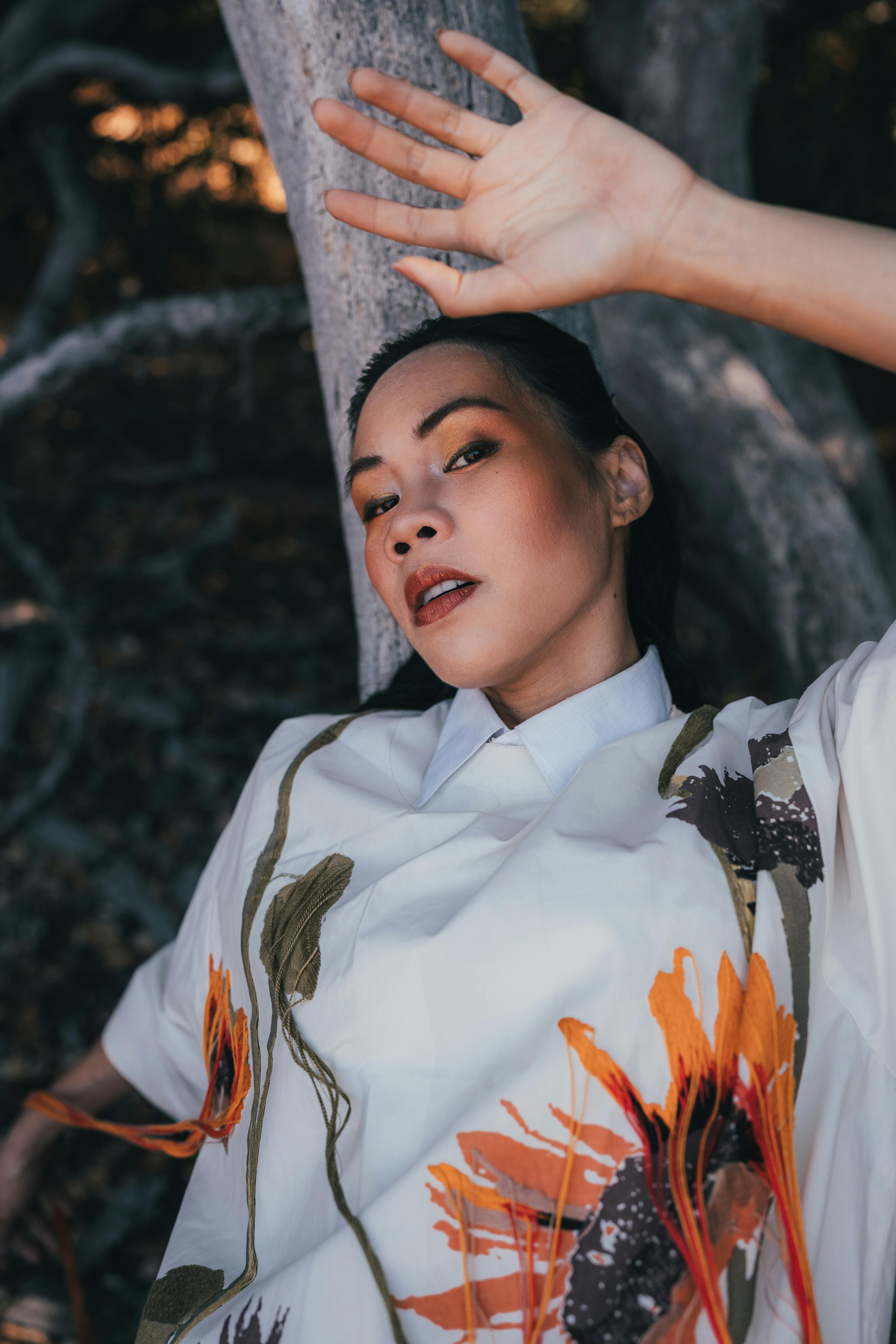 Low angle view of woman with hands raised · Free Stock Photo