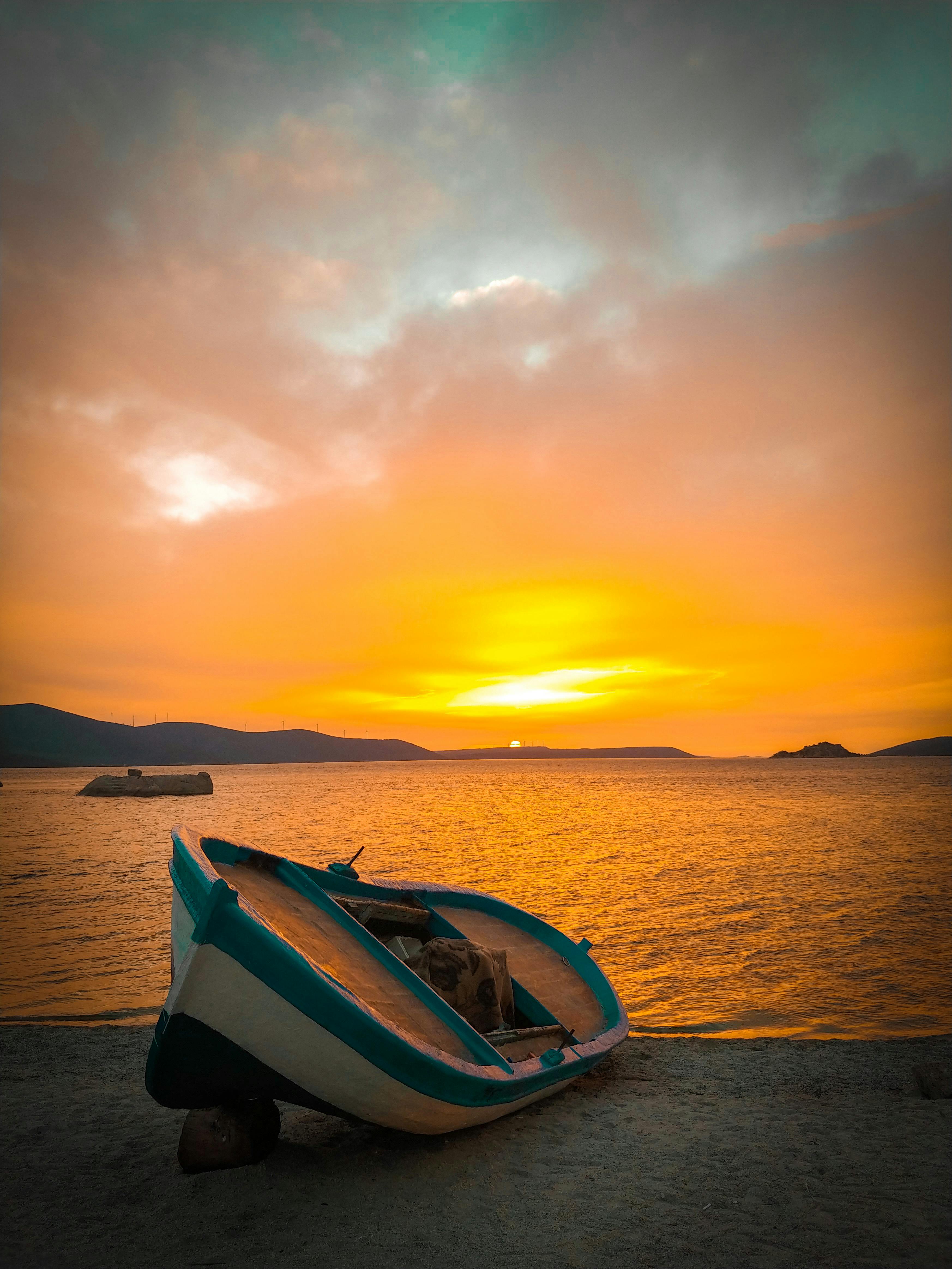 A Boat on the Beach during Sunset · Free Stock Photo