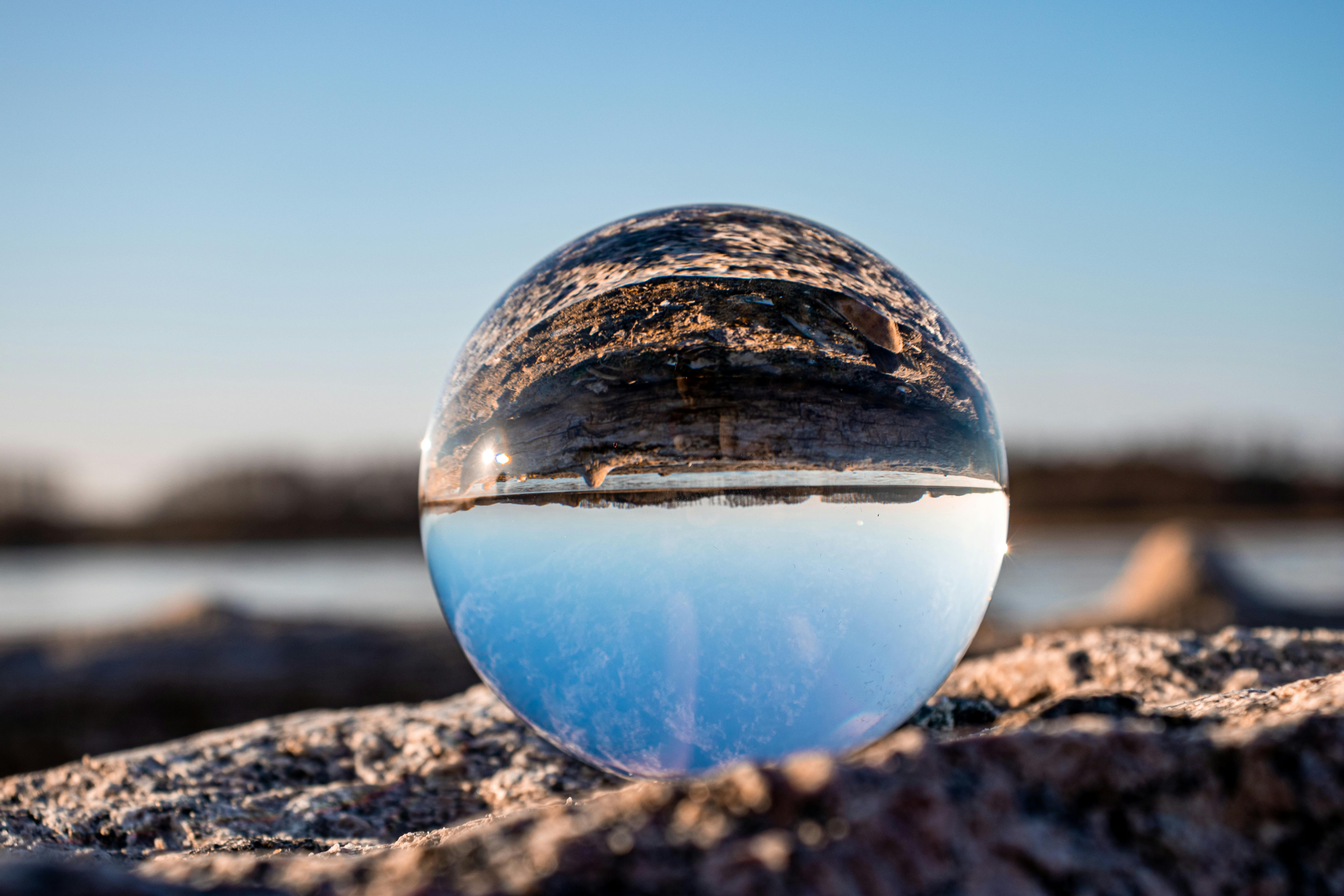 Crystal Ball Reflecting Rocky Beach Landscape · Free Stock Photo