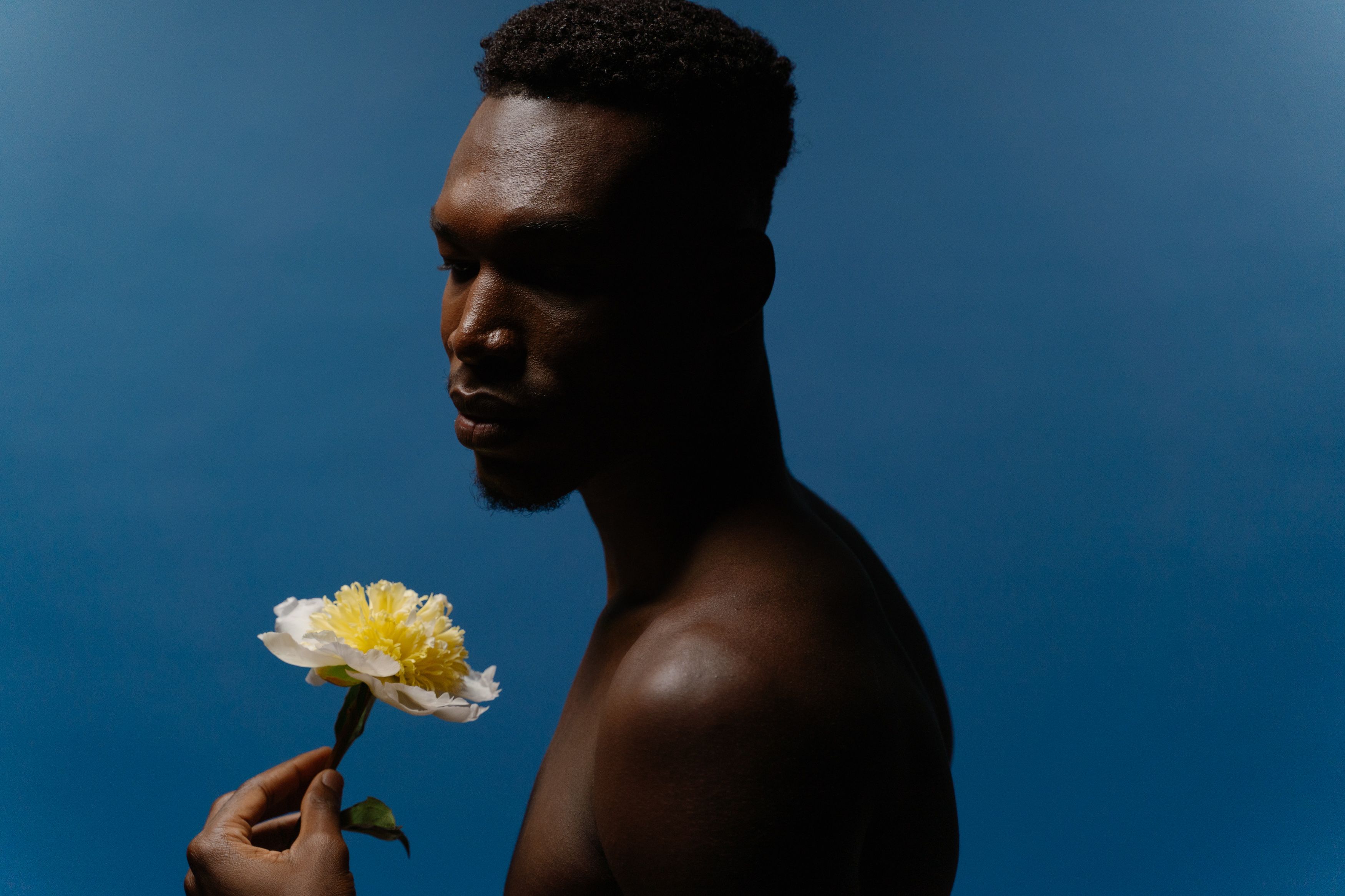 A Man Standing with a Flower · Free Stock Photo