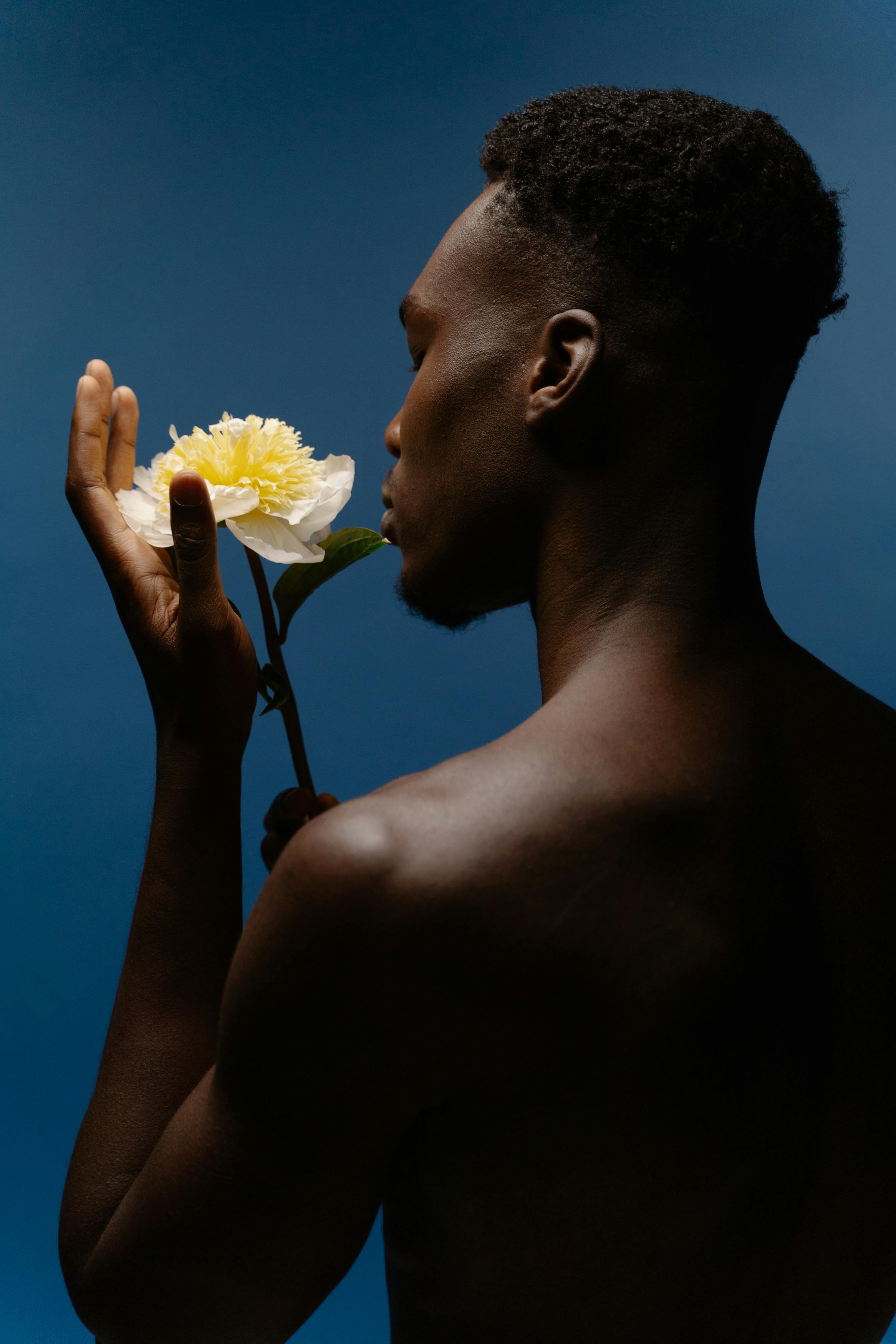 A Man Standing with a Flower · Free Stock Photo