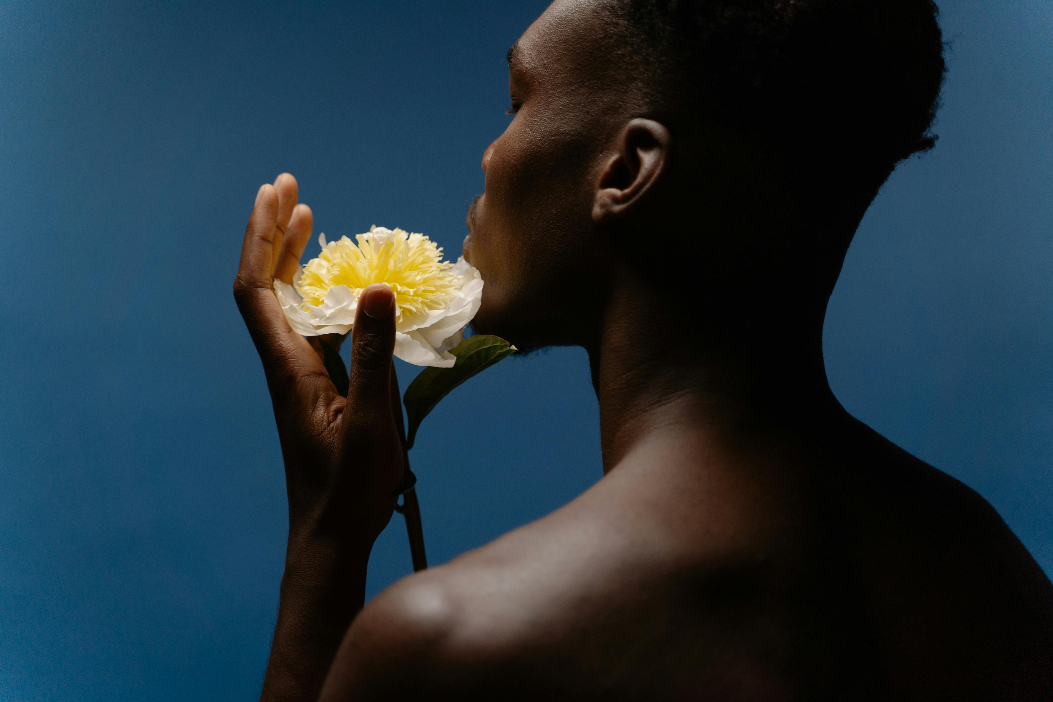 A Man Standing with a Flower · Free Stock Photo
