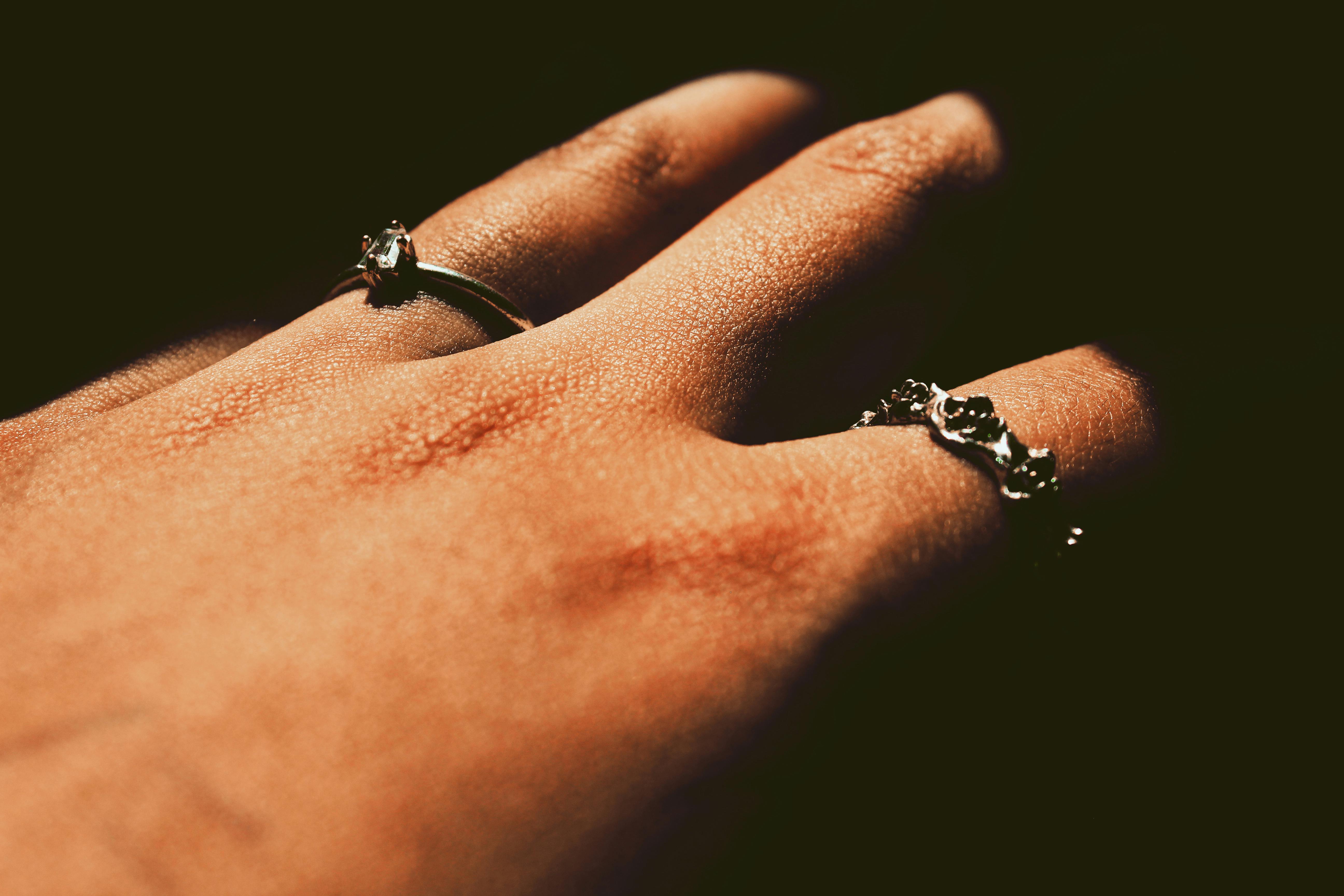 Close-Up Photo of a Person Wearing Silver Rings · Free Stock Photo