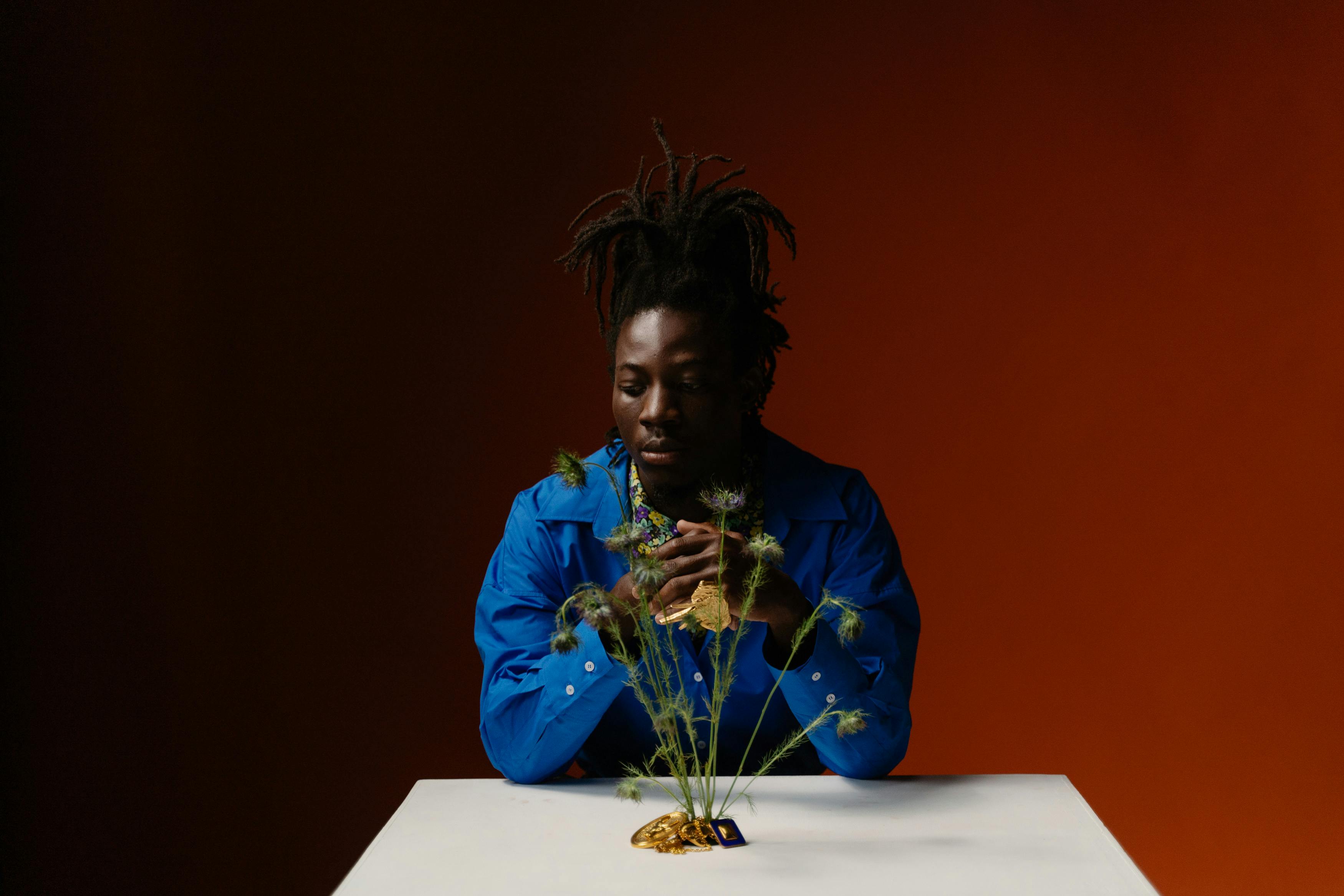 Man in Blue Long Sleeve Shirt Wearing a Gold Ring · Free Stock Photo