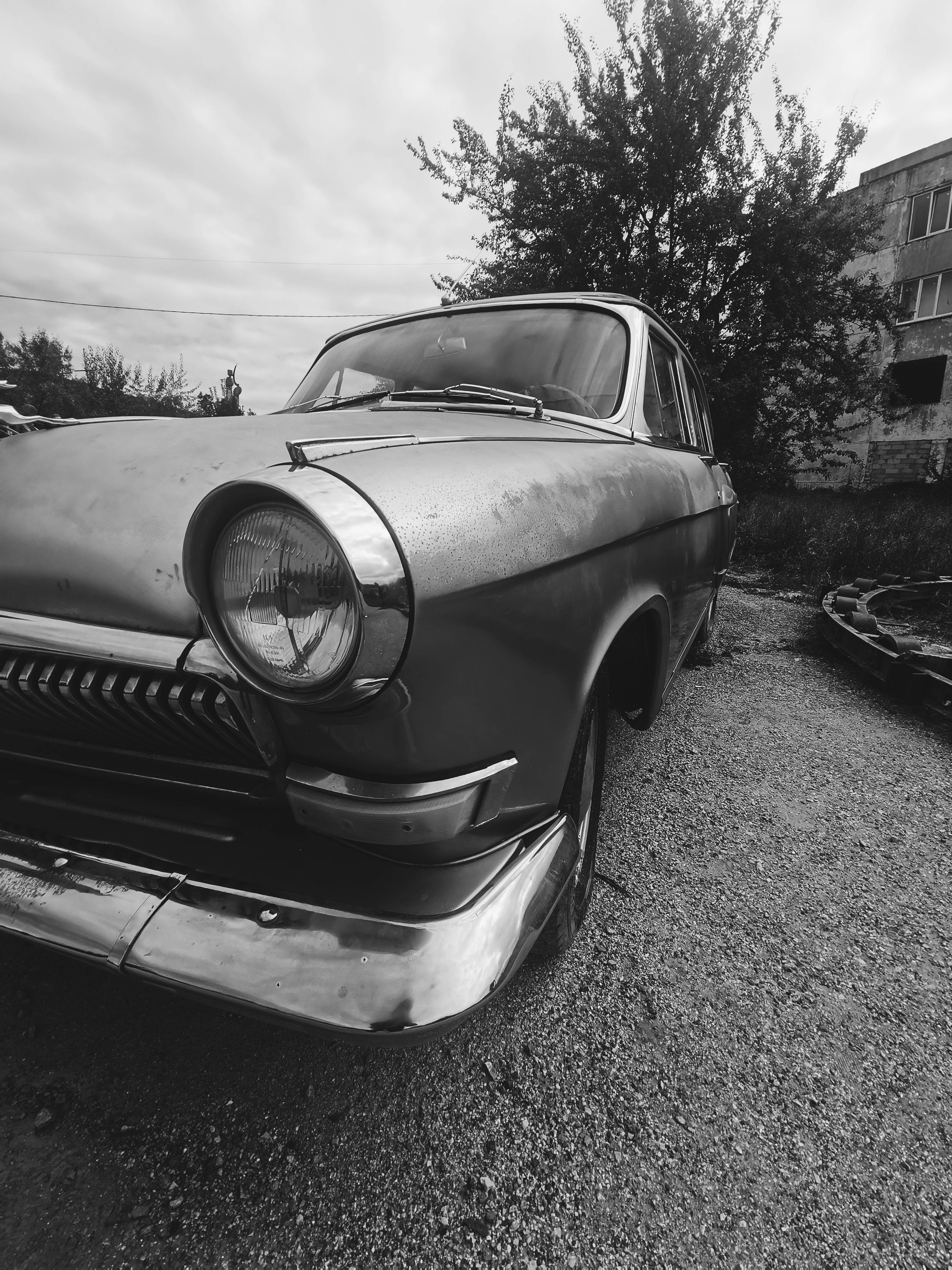 Vintage Car Riding on a Street in Black and White · Free Stock Photo