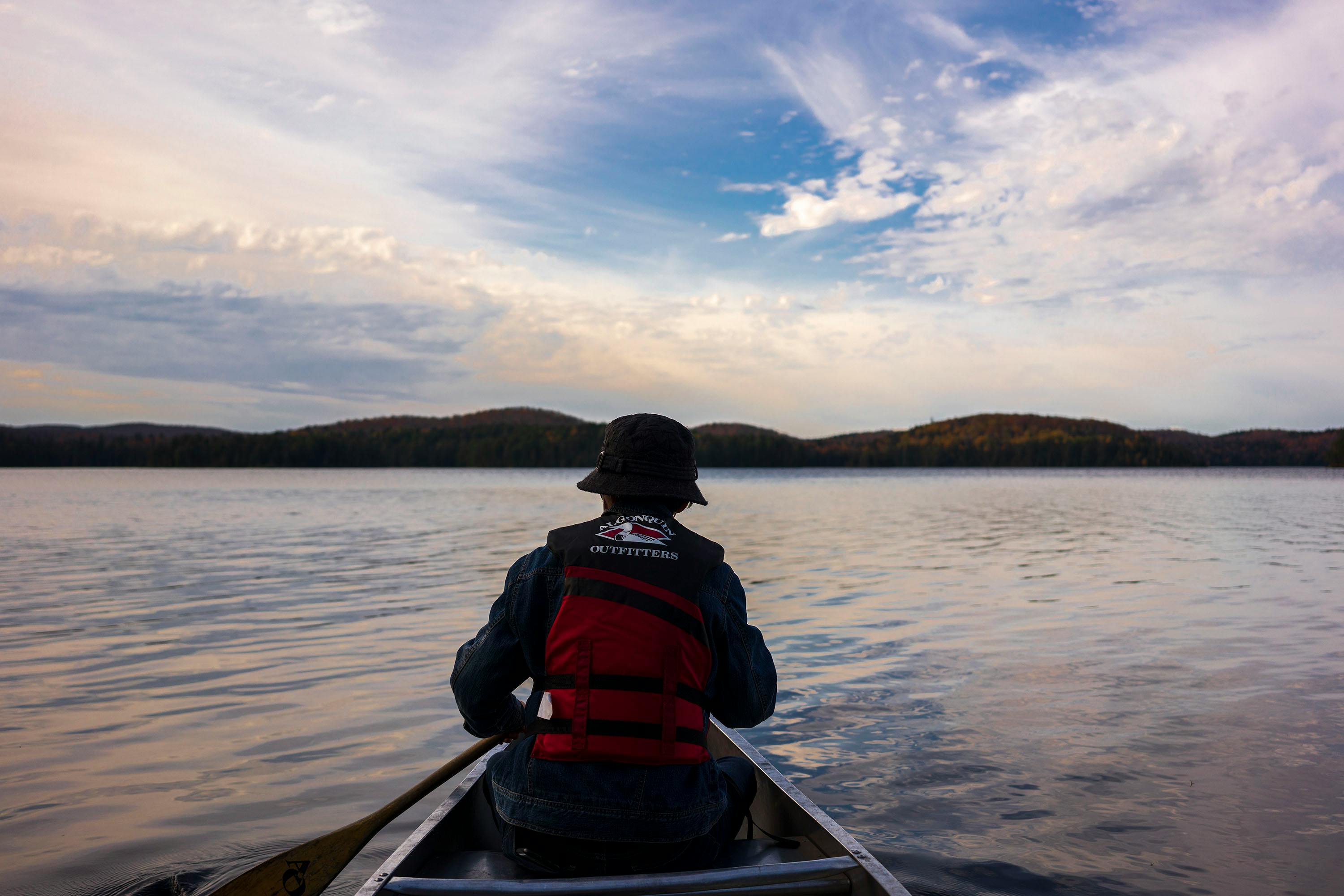 Back View of a Person Paddling on a Canoe · Free Stock Photo