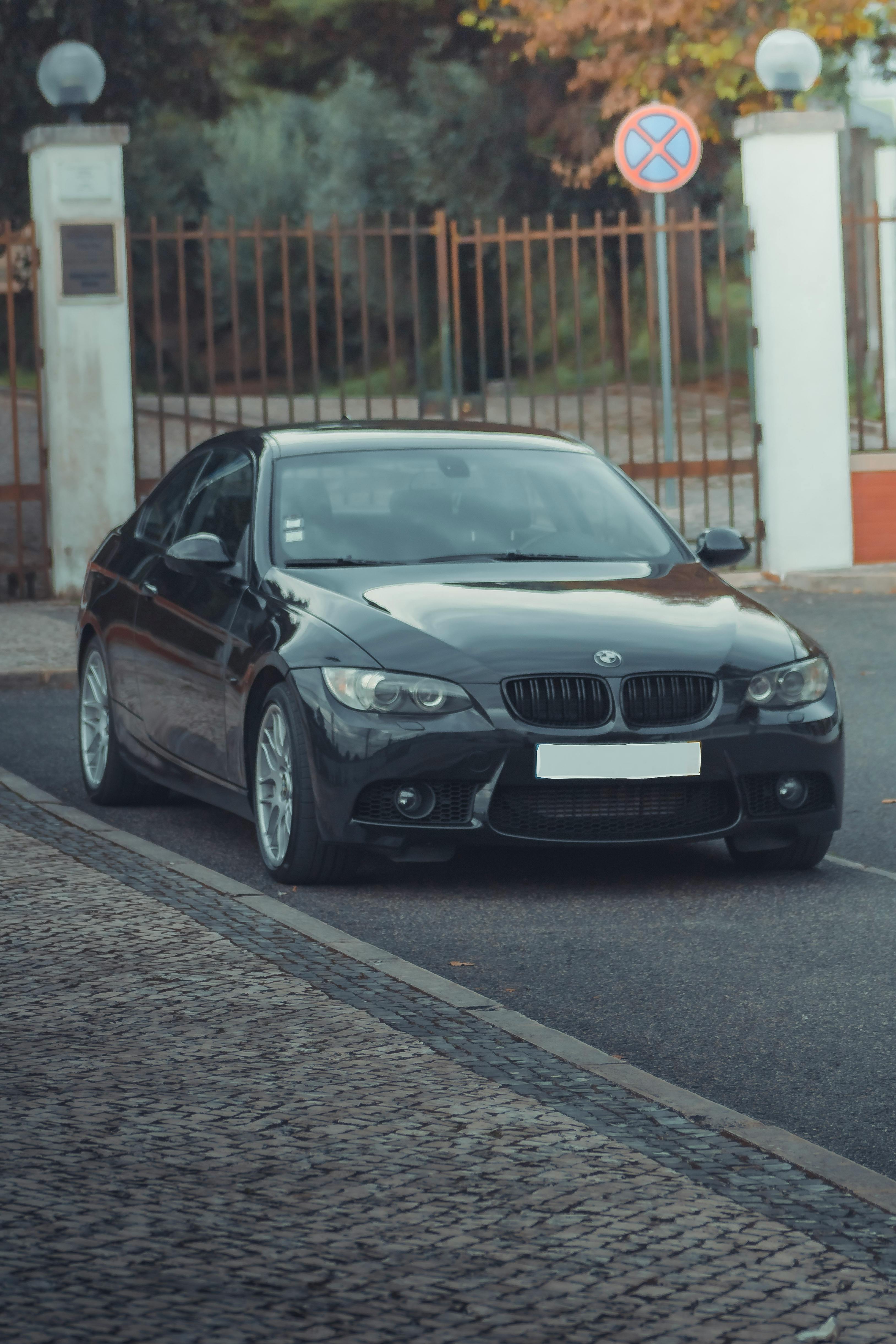Parked BMW near a Gate · Free Stock Photo