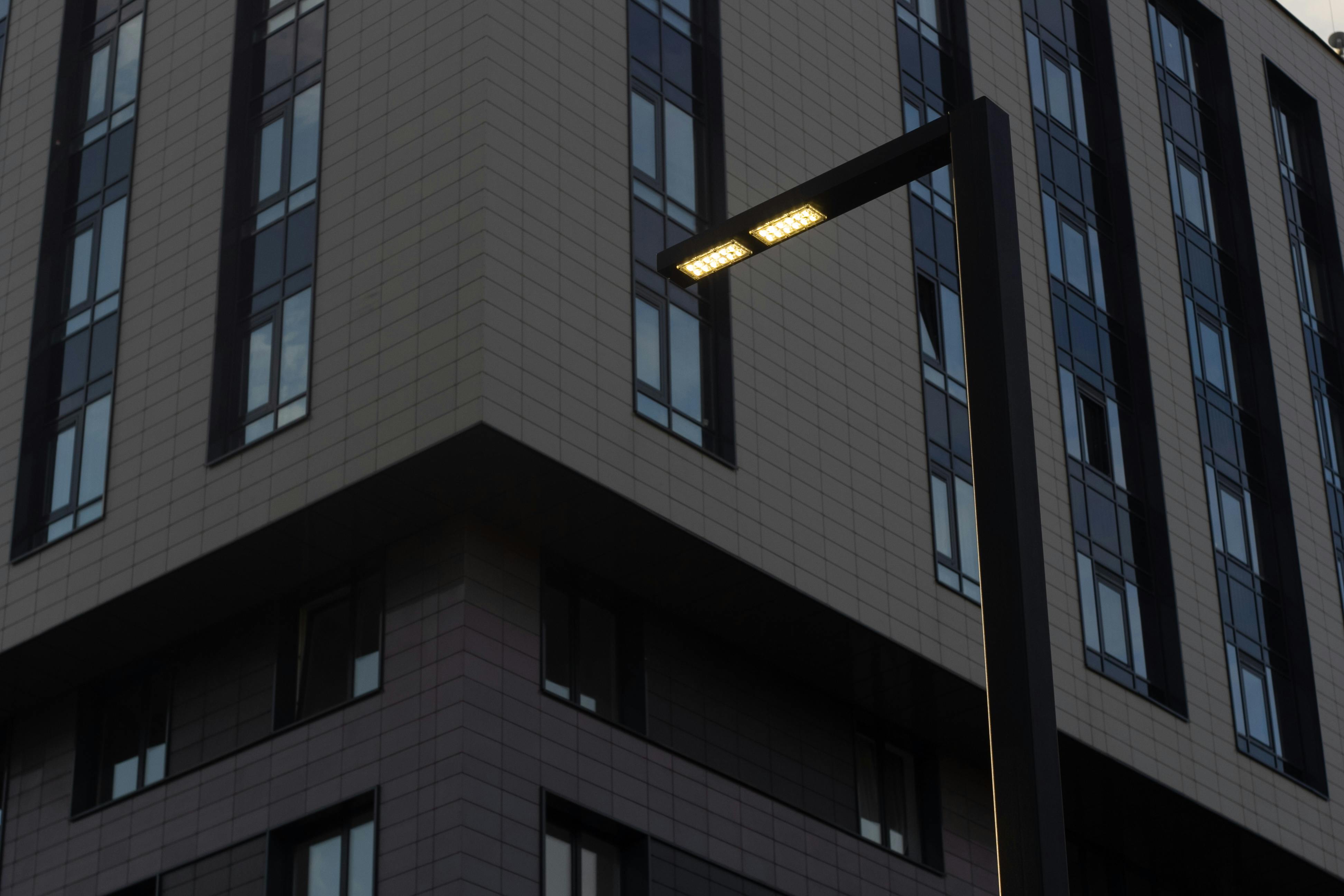 Illuminated Street Light Beside the Concrete Building · Free Stock Photo