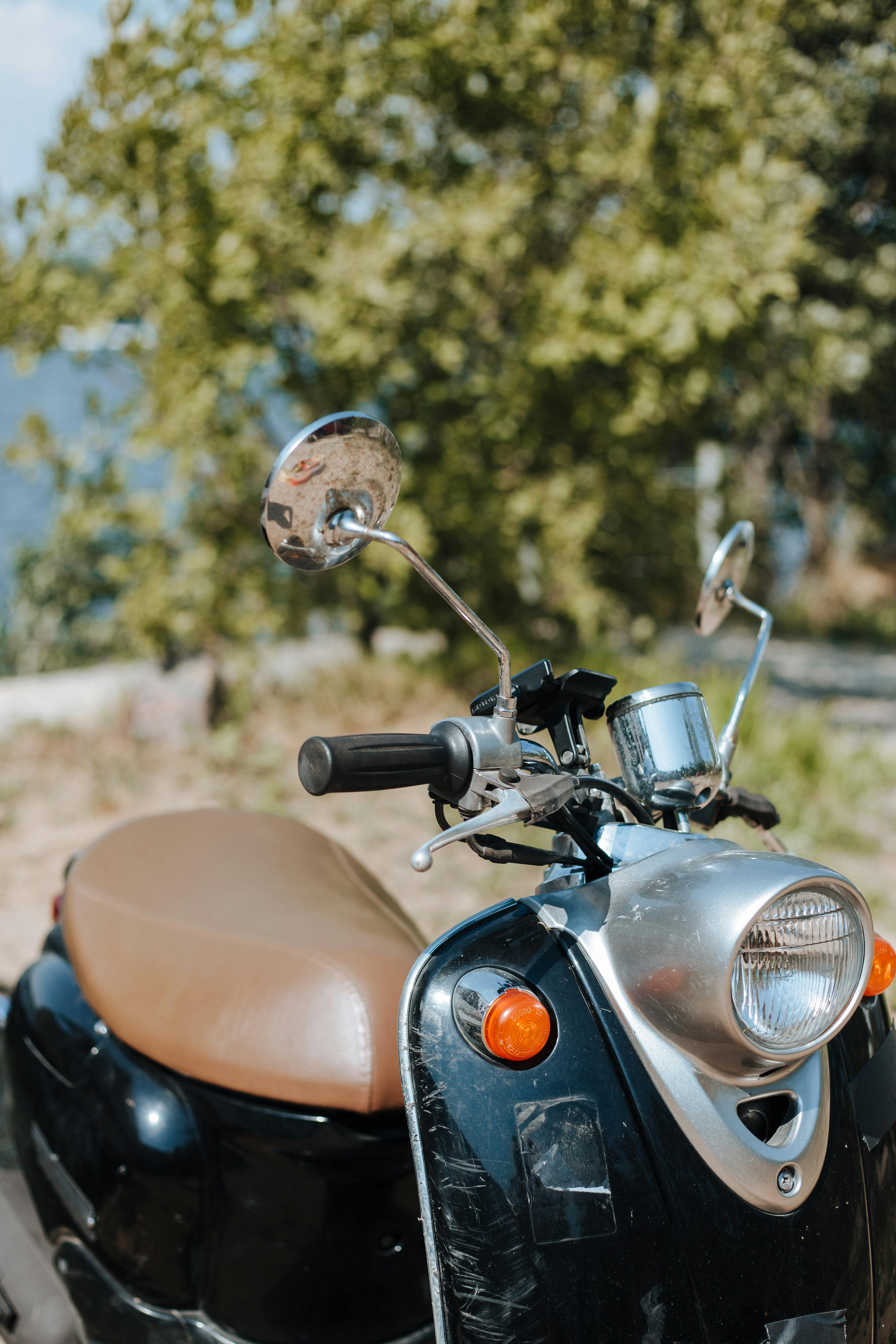 Red and Black Moped Scooter Beside Green Grass · Free Stock Photo
