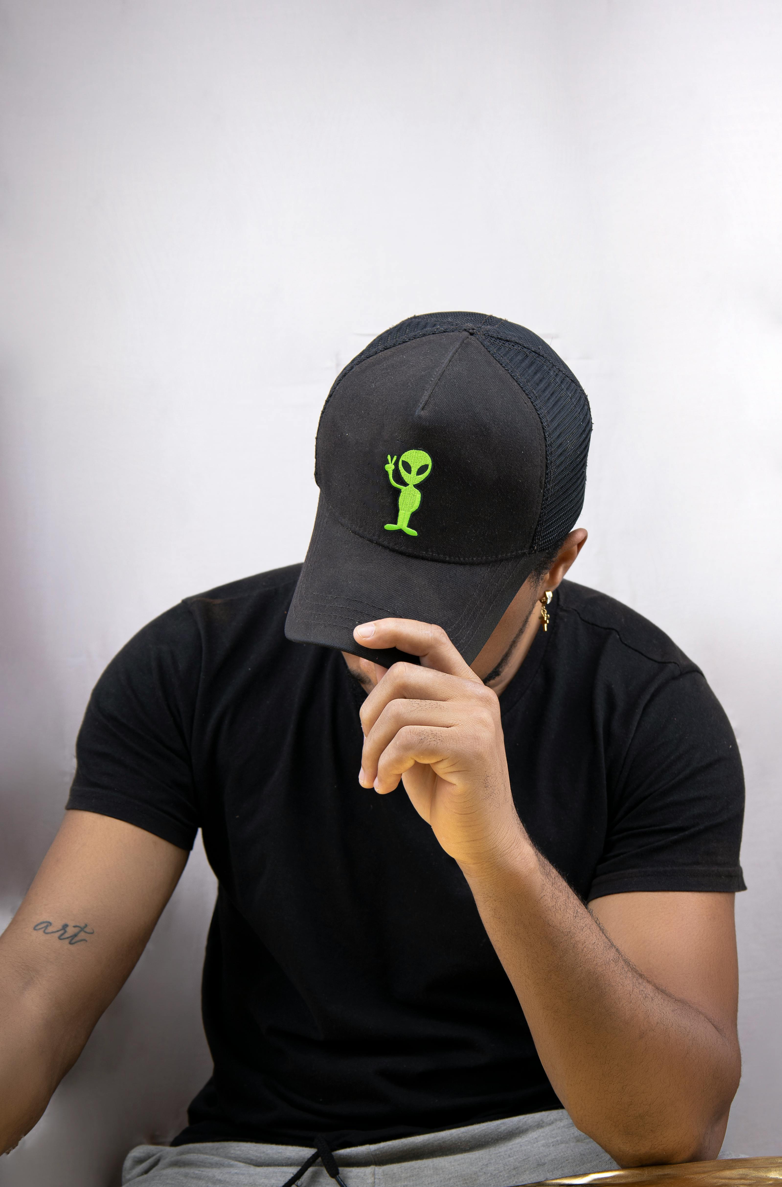 Man in a Photoshoot Holding his Cap · Free Stock Photo