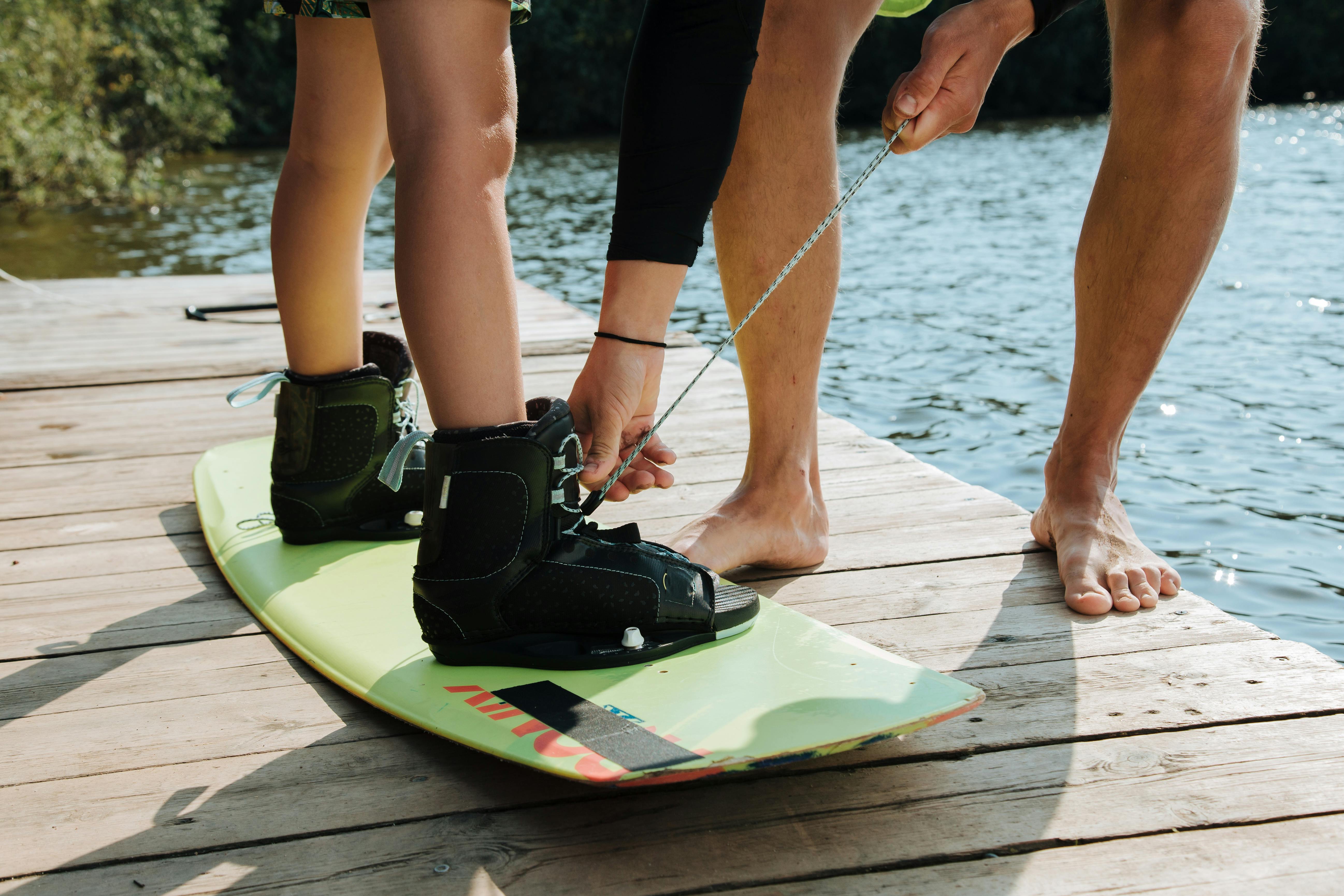 Parent Preparing Son for Wakeboarding · Free Stock Photo
