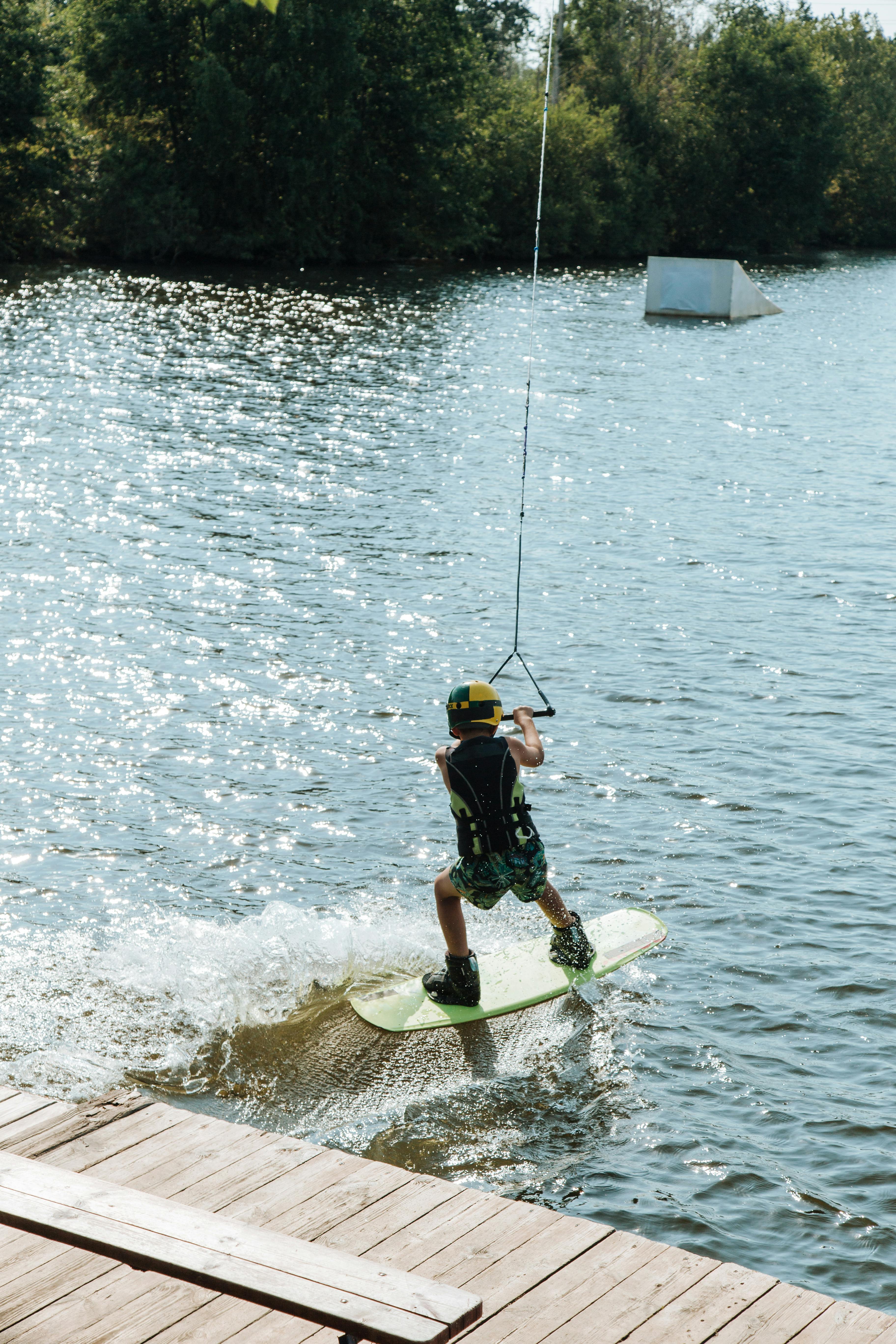 Young Kid Jumping on Wakeboard · Free Stock Photo