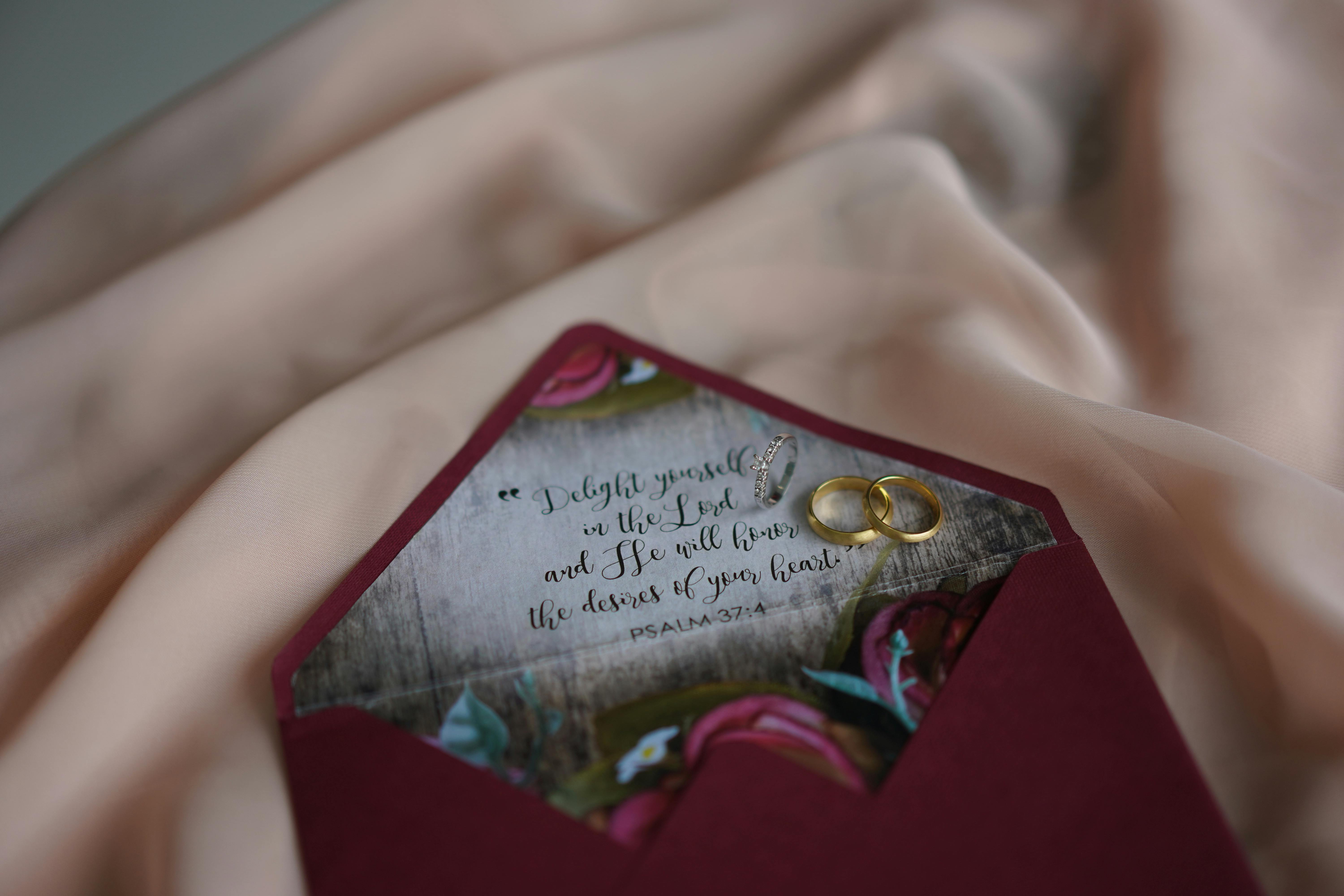 Maroon Envelope with Gold Rings · Free Stock Photo