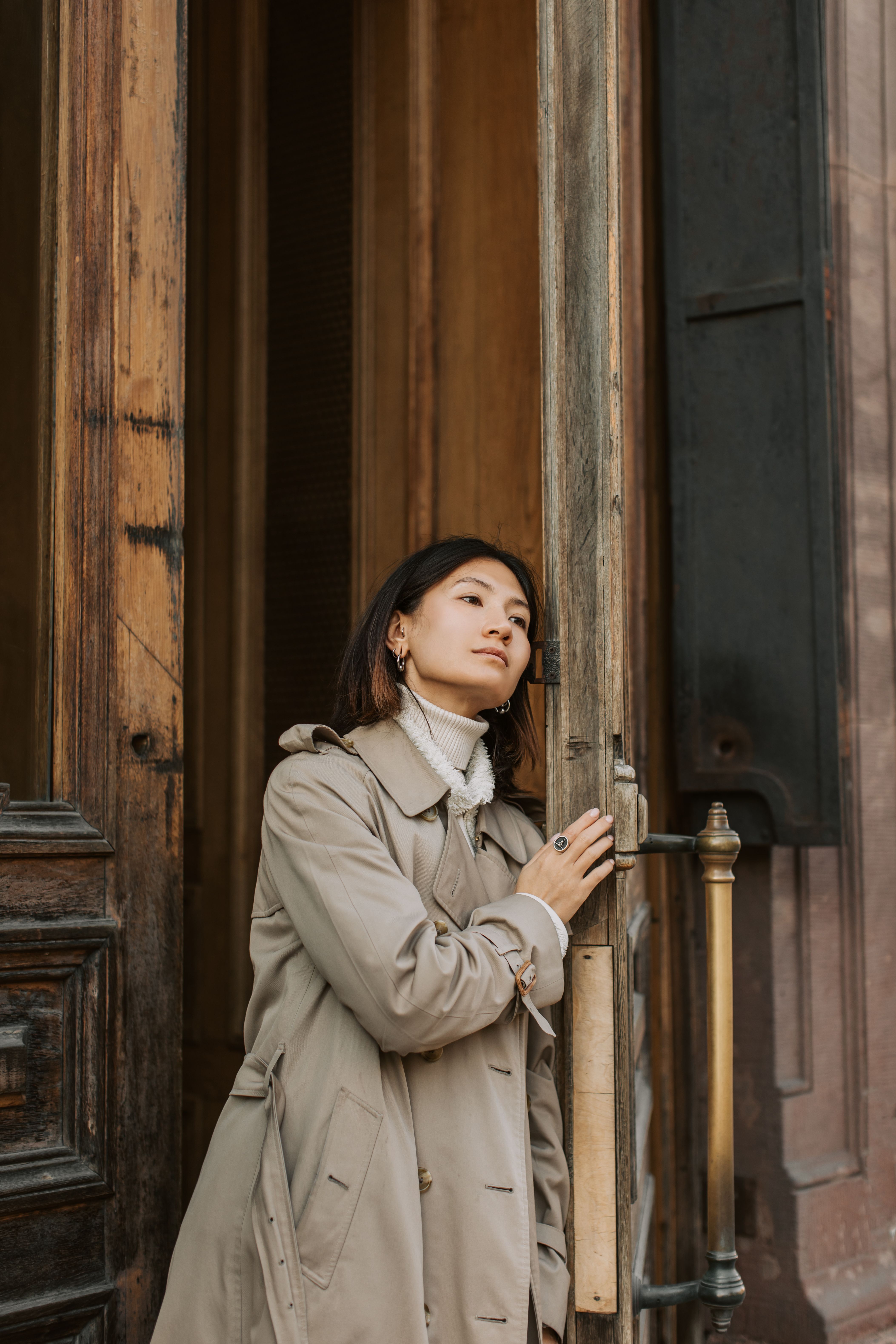 Woman Standing Beside a Door · Free Stock Photo