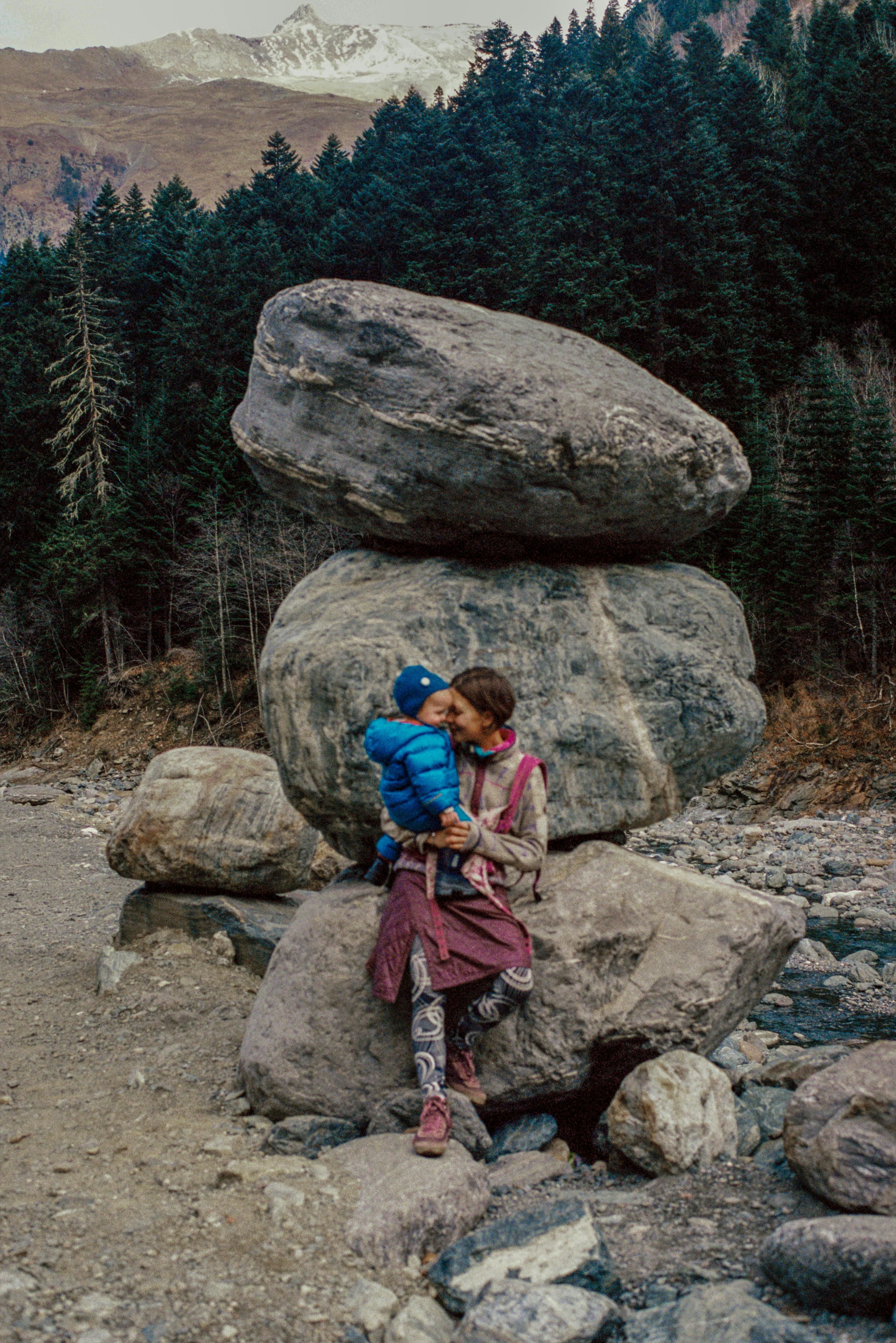 Woman Carrying a Toddler Sitting on Big Rocks · Free Stock Photo